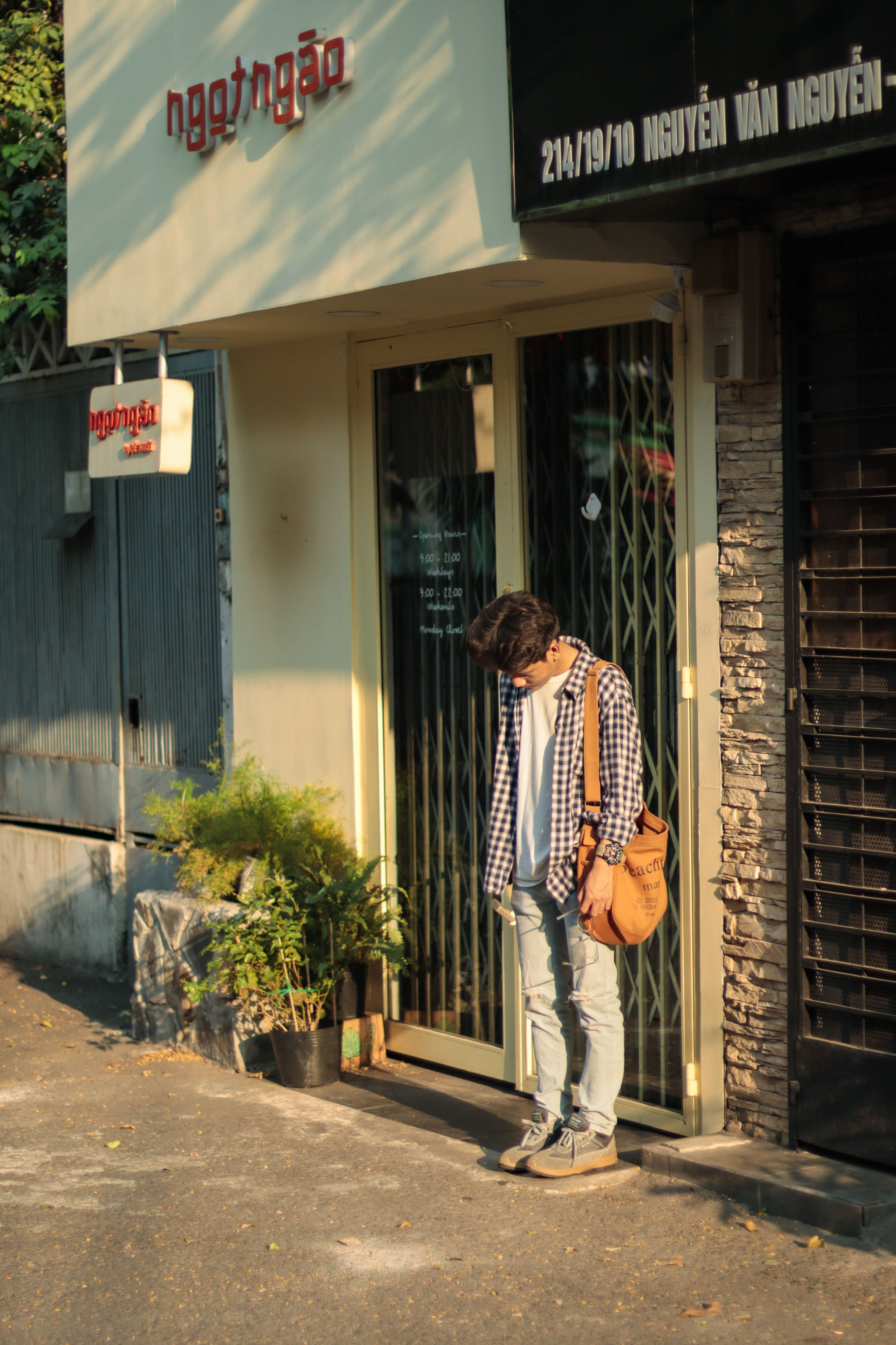 Young Man Standing Outside Urban Storefront · Free Stock Photo