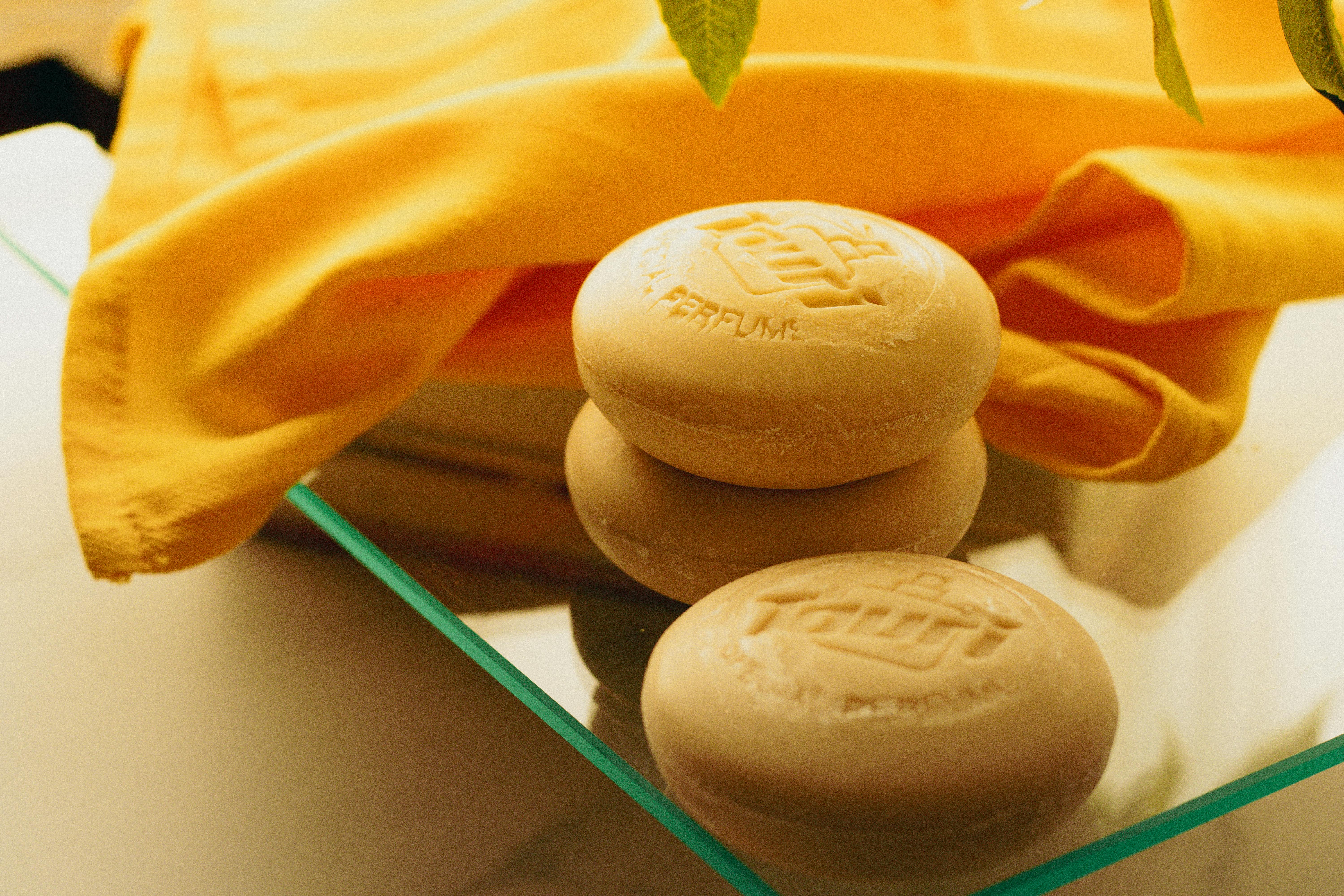 Elegant Display of Round Soap Bars on Mirror · Free Stock Photo