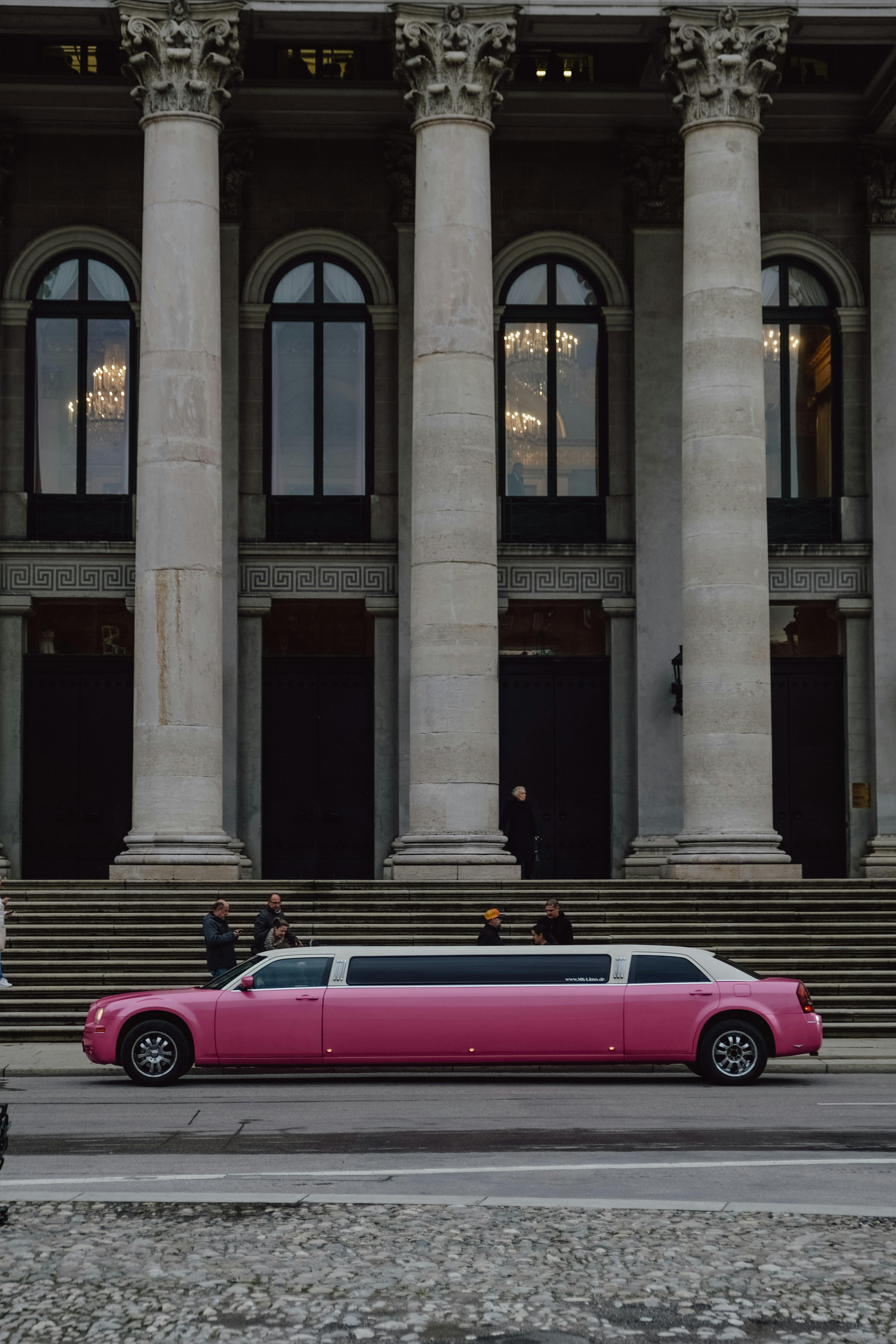 Elegant Photo of a Pink Limousine in Urban Setting · Free Stock Photo