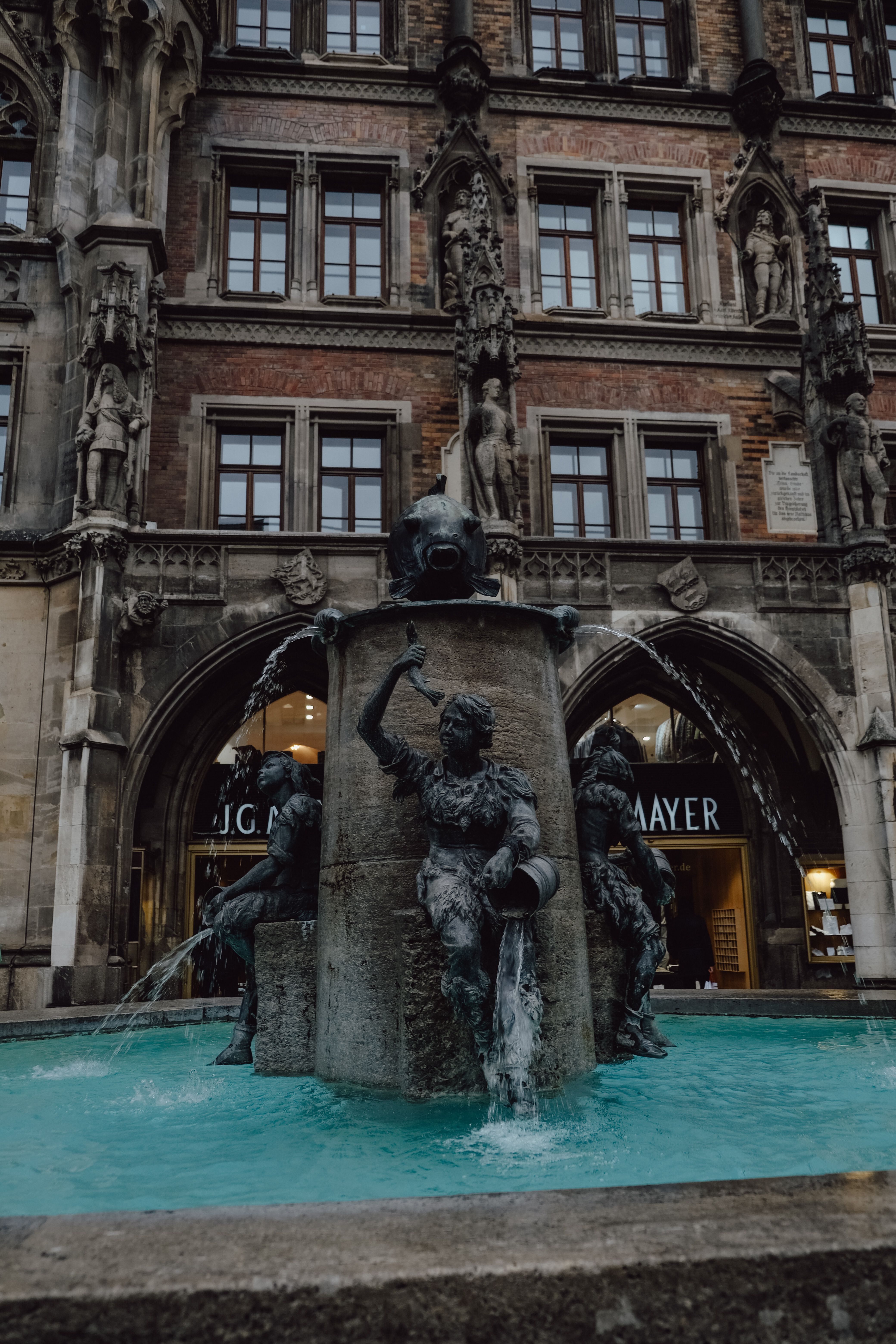 Historic Fountain Outside Ornate Gothic Building · Free Stock Photo