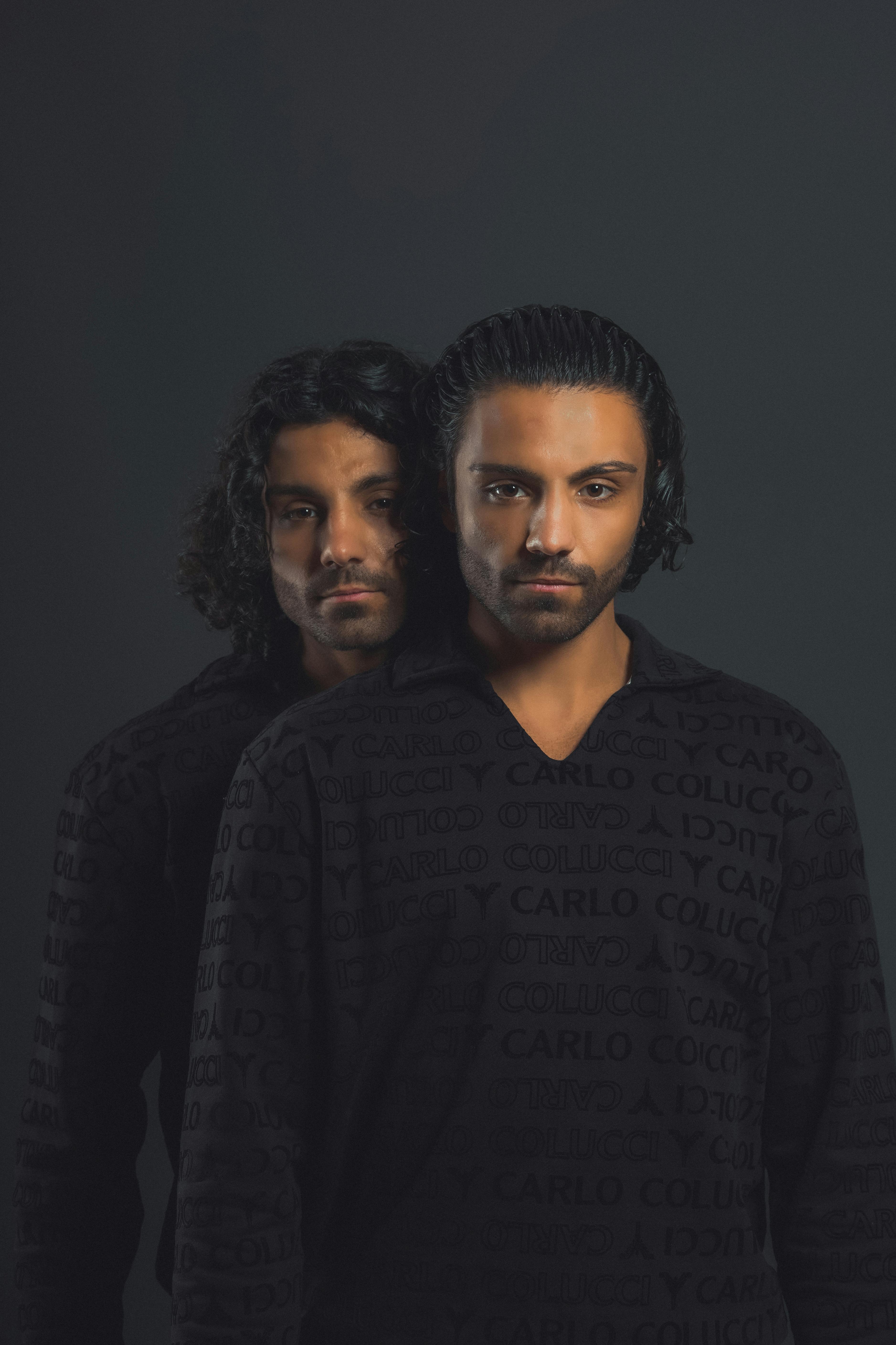 Moody Portrait of Two Young Men in Dark Attire · Free Stock Photo