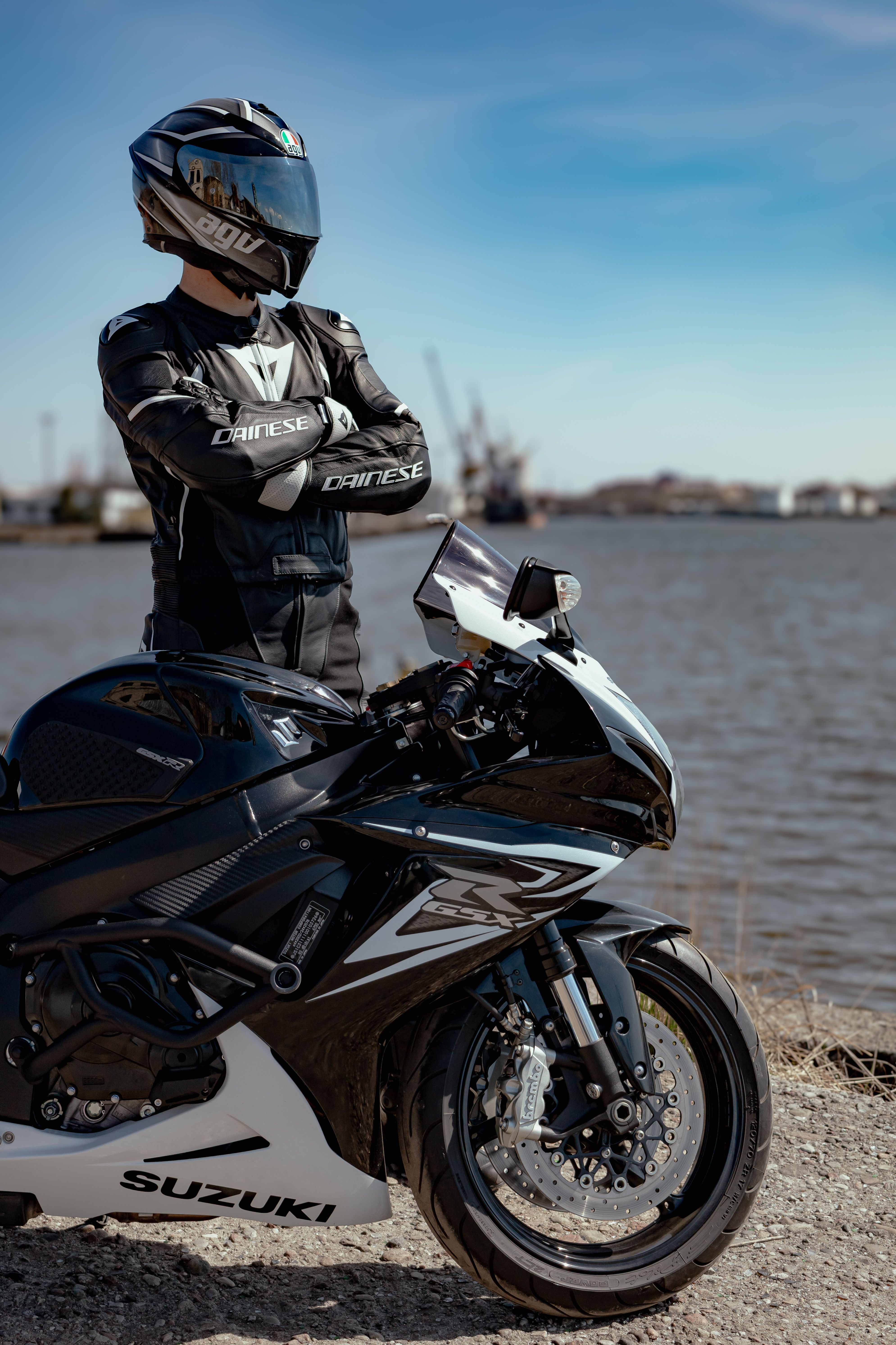 Motorcyclist in Gear by Riverside · Free Stock Photo