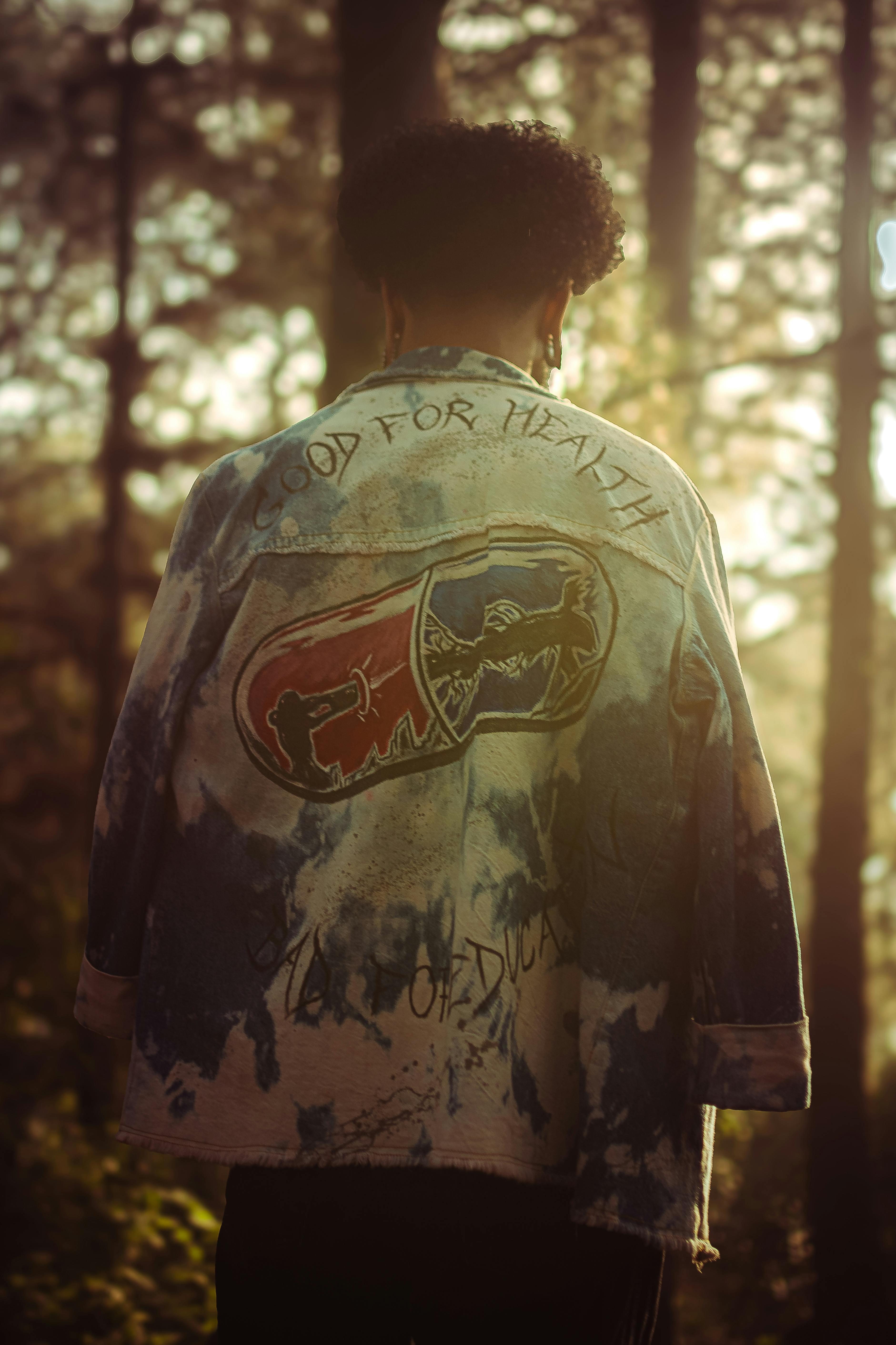 Urban Style Denim Jacket in Mystical Forest Setting · Free Stock Photo