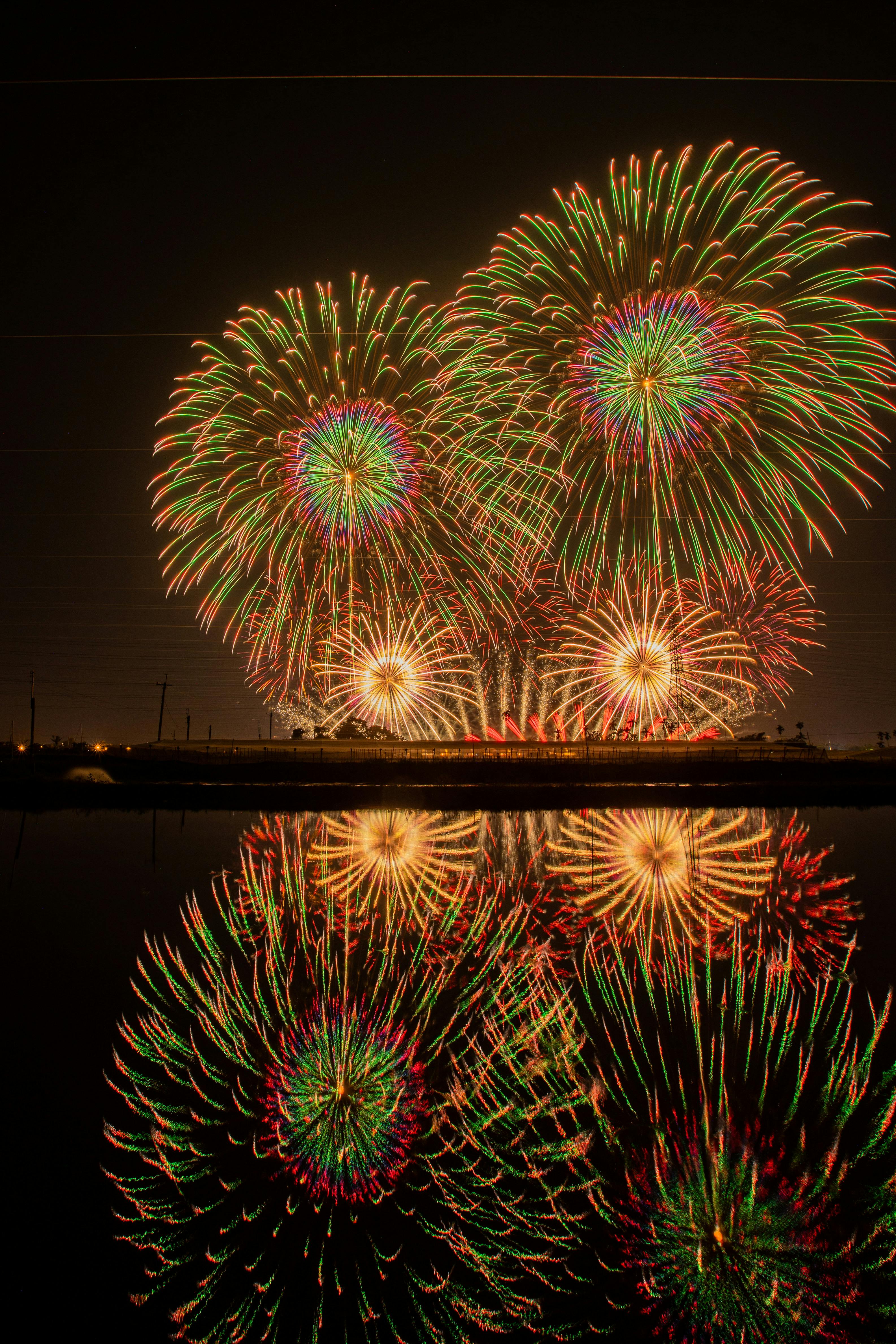 Vibrant Fireworks Display Reflecting Over Water · Free Stock Photo