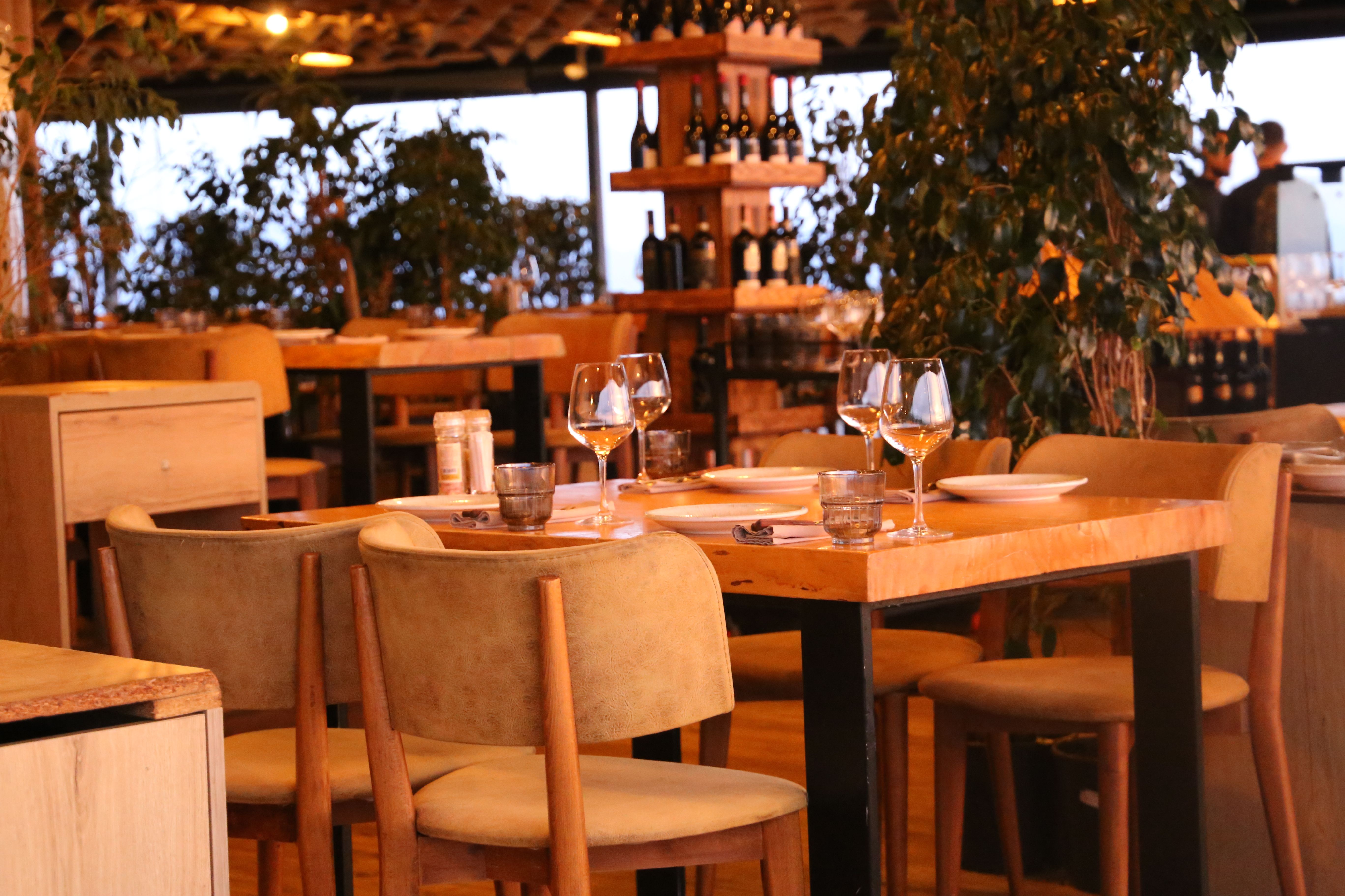Cozy Restaurant Interior with Set Table · Free Stock Photo