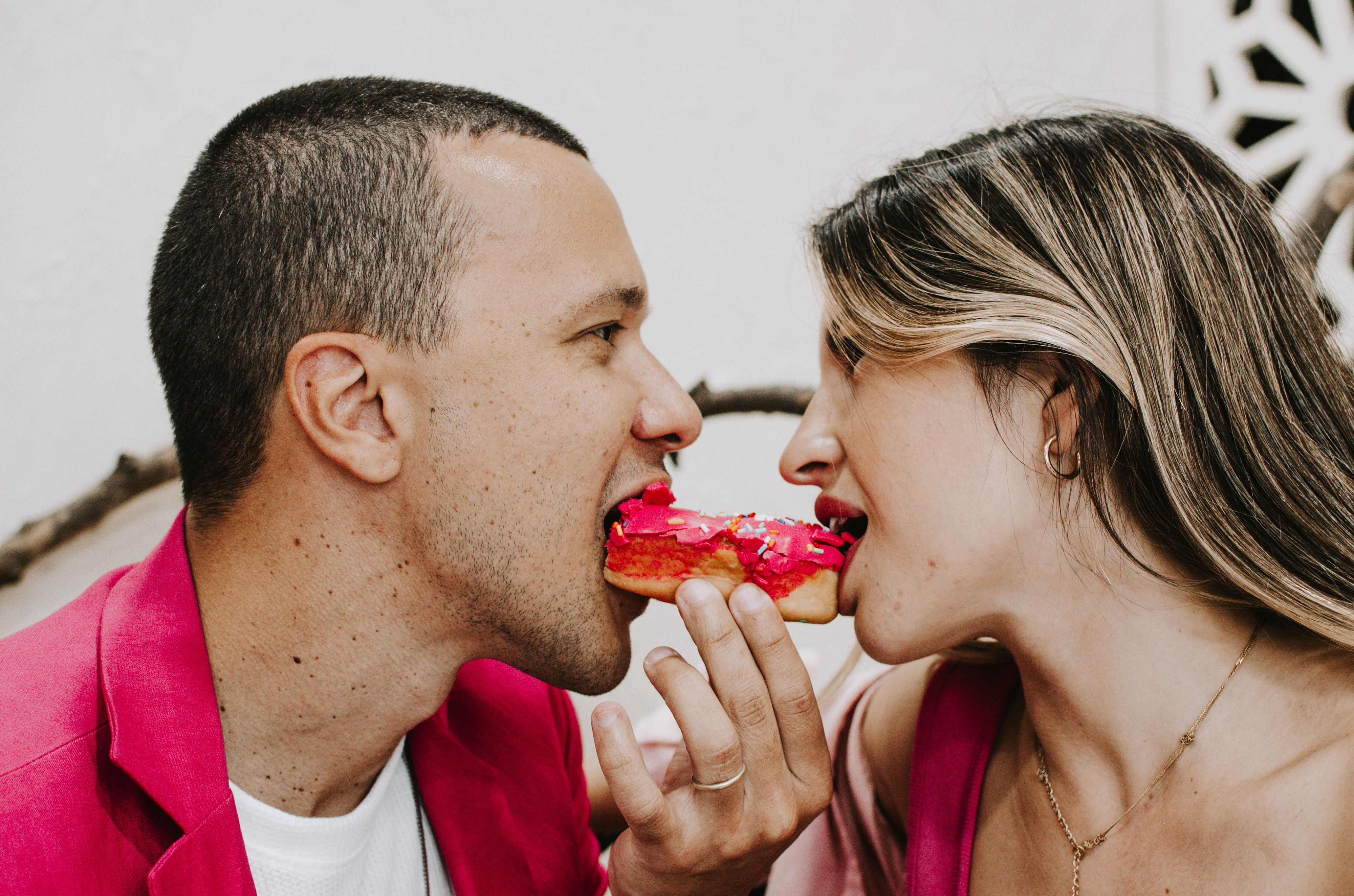 Couple Sharing a Colorful Doughnut in Buenos Aires · Free Stock Photo