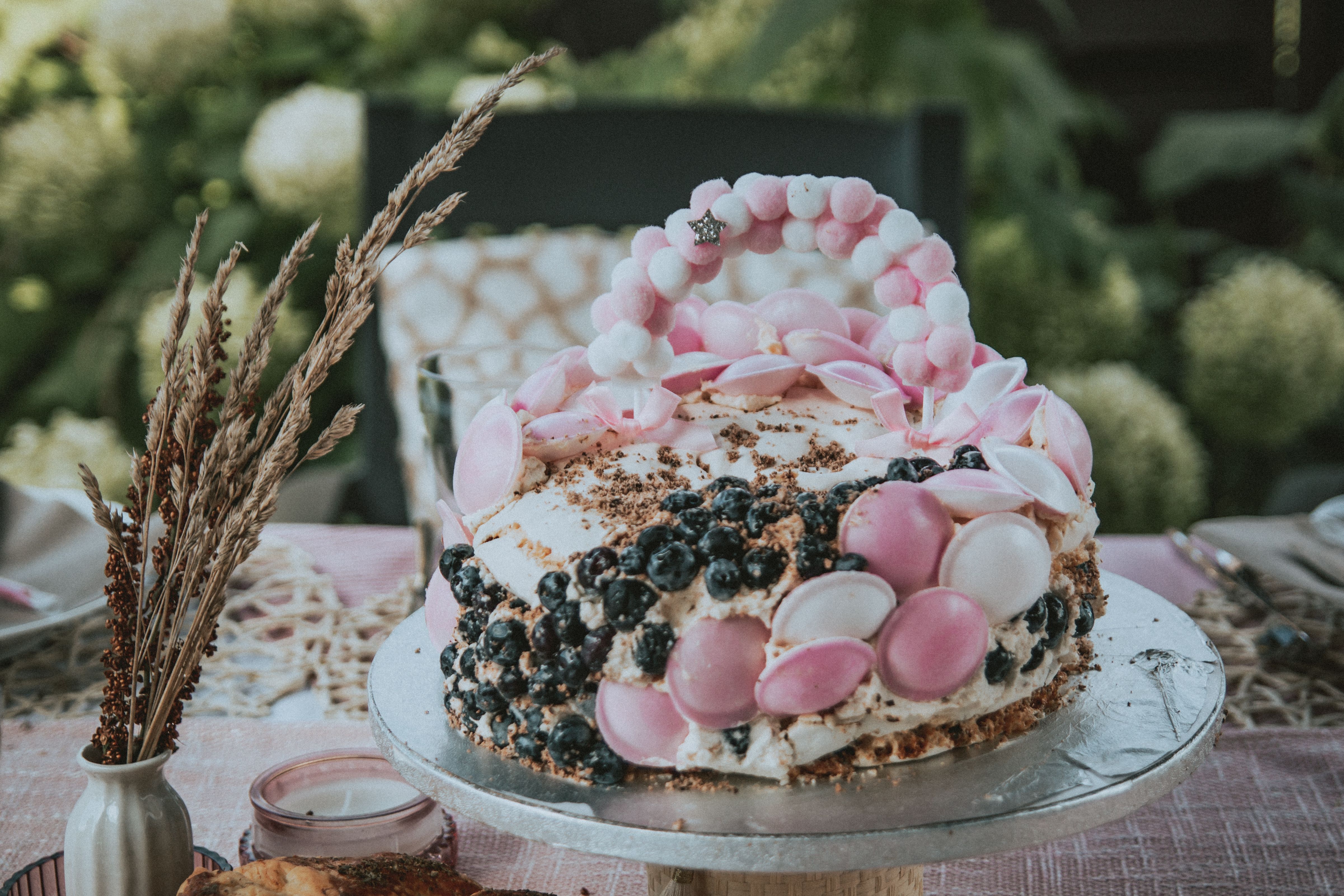 Elegant Berry and Meringue Cake in Outdoor Setting · Free Stock Photo
