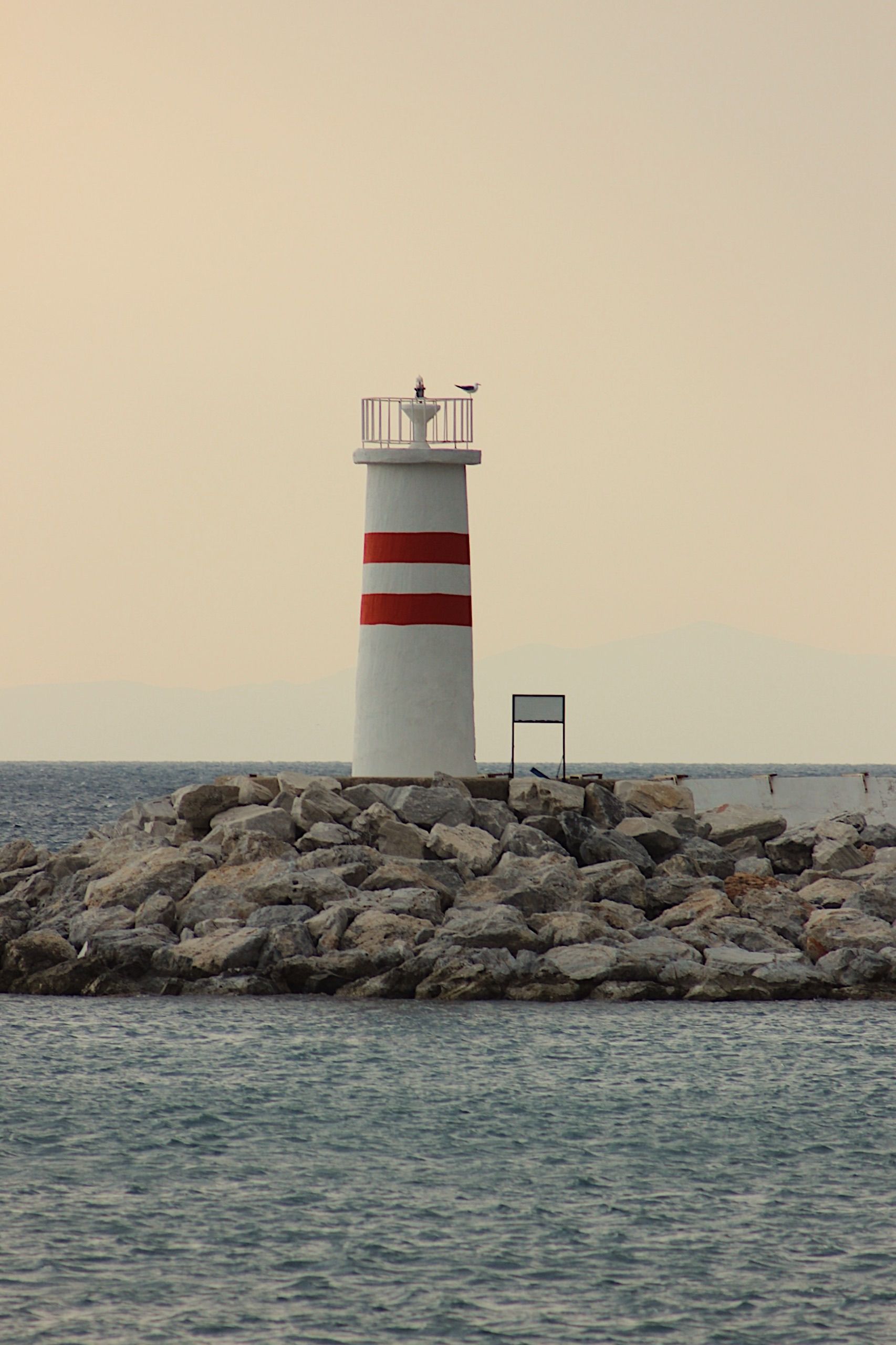 Picturesque Coastal Lighthouse in Tranquil Setting · Free Stock Photo