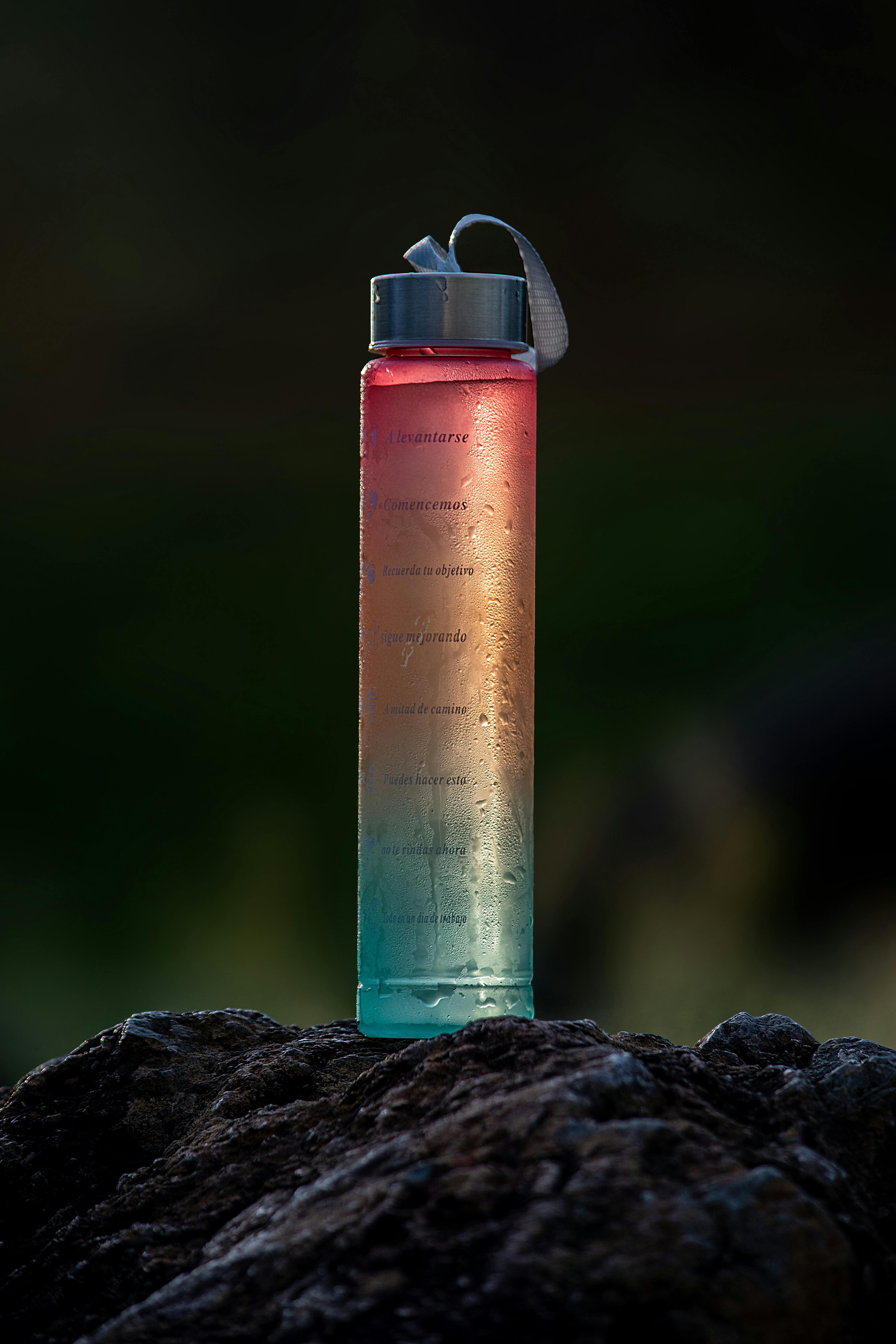Colorful Gradient Water Bottle Outdoors · Free Stock Photo