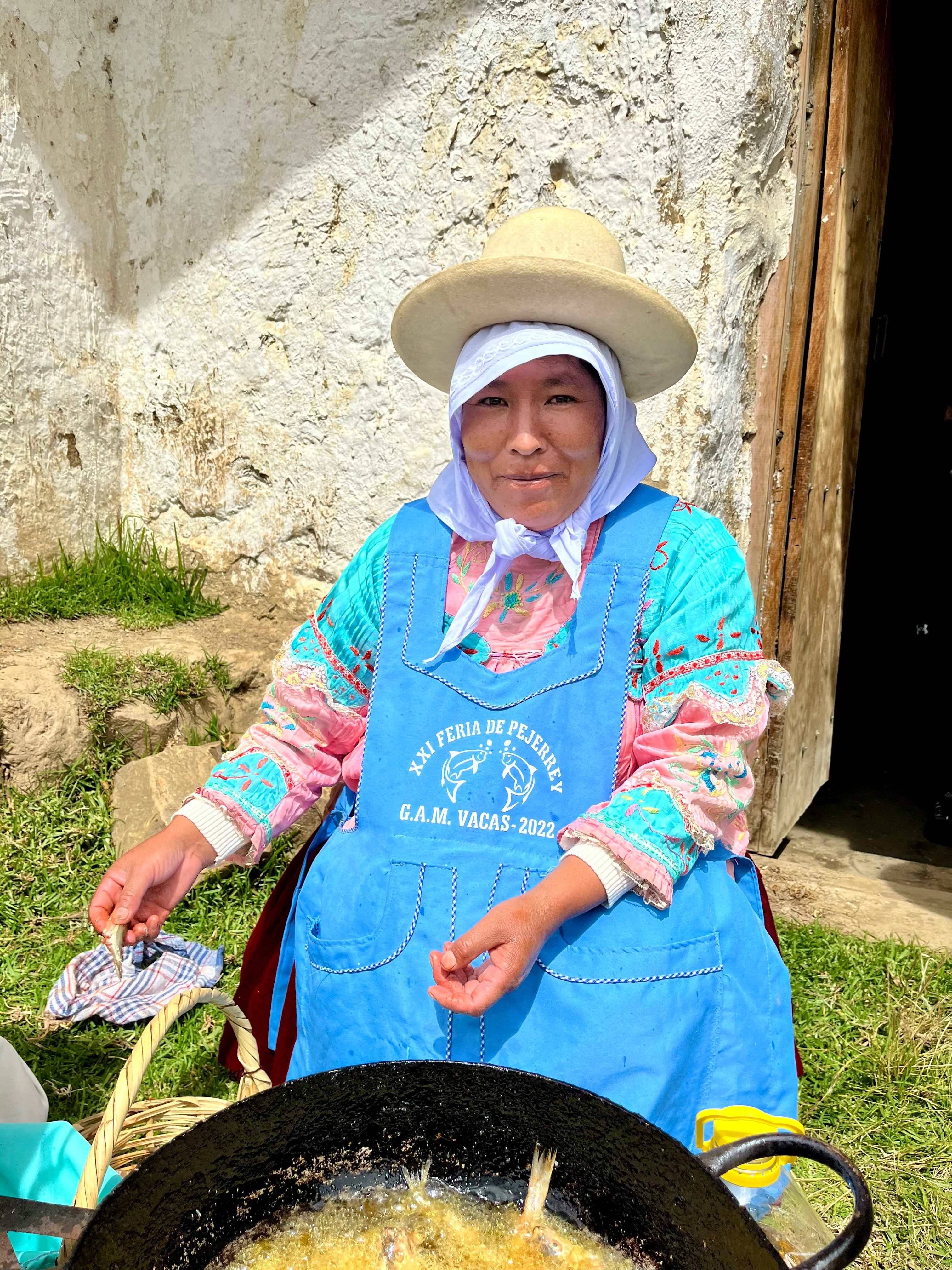 Andean Woman Cooking Traditional Food Outdoors · Free Stock Photo