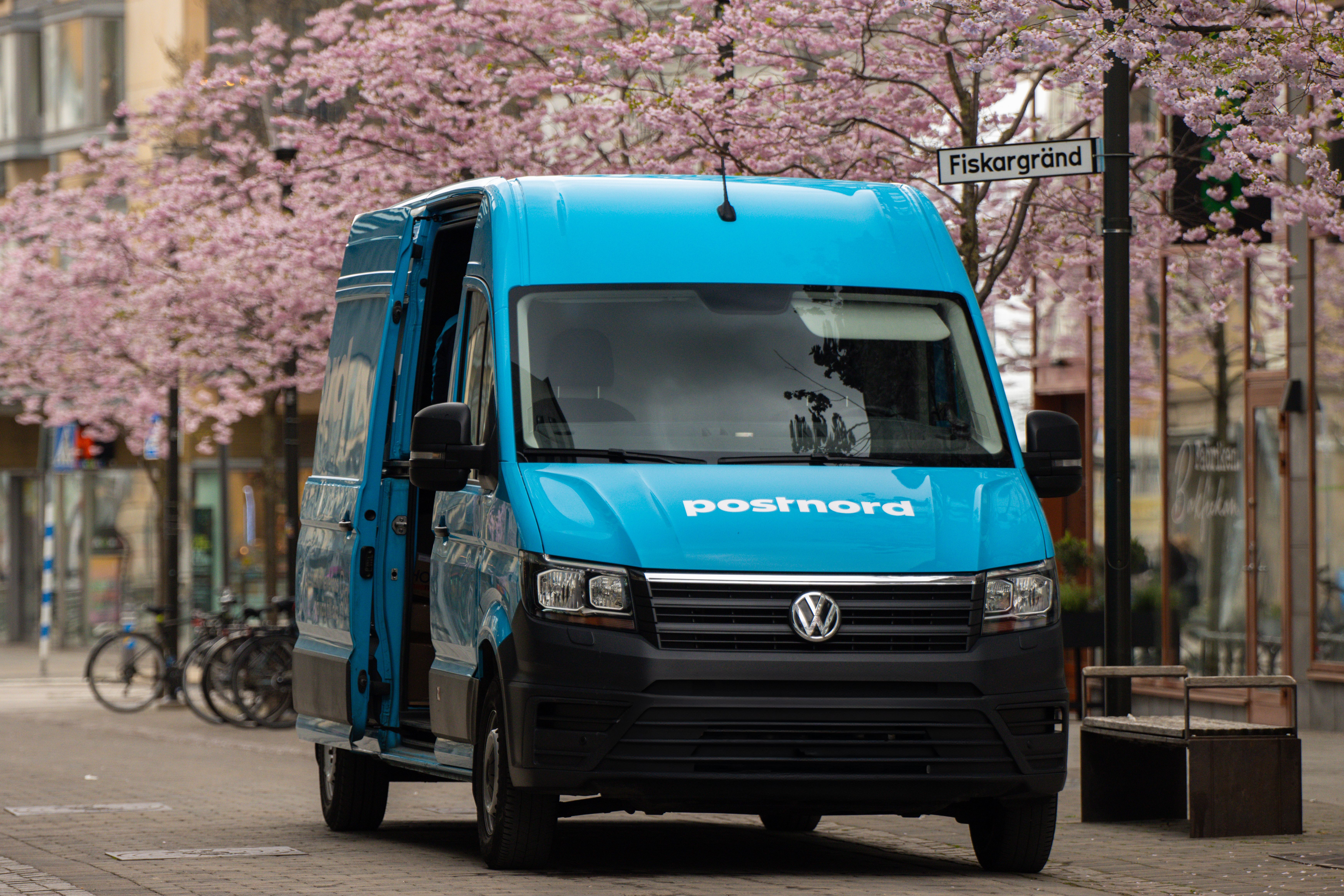 Blue Delivery Van by Cherry Blossoms in Sweden · Free Stock Photo