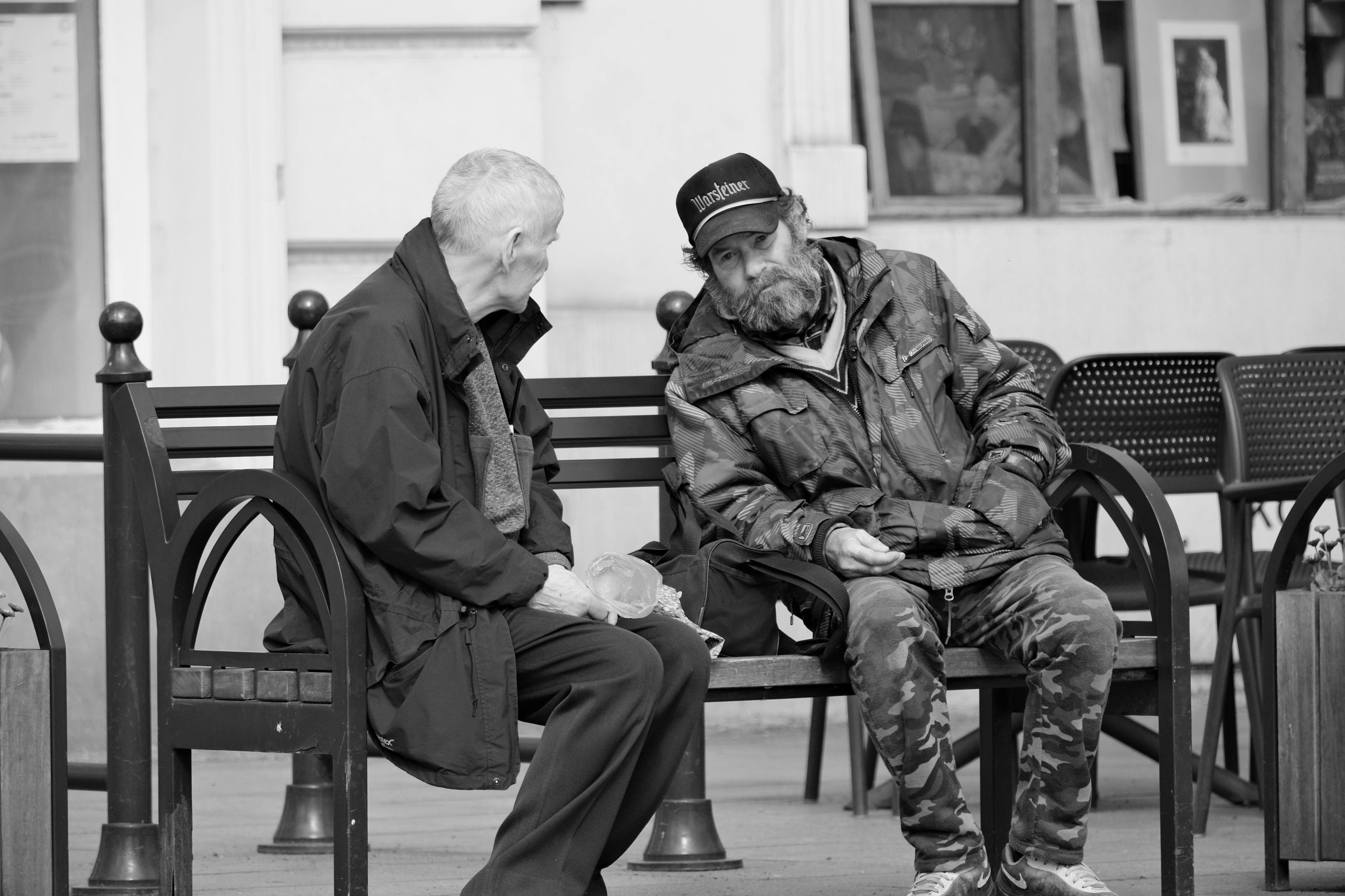 Candid Conversation Between Two Men on a City Bench · Free Stock Photo