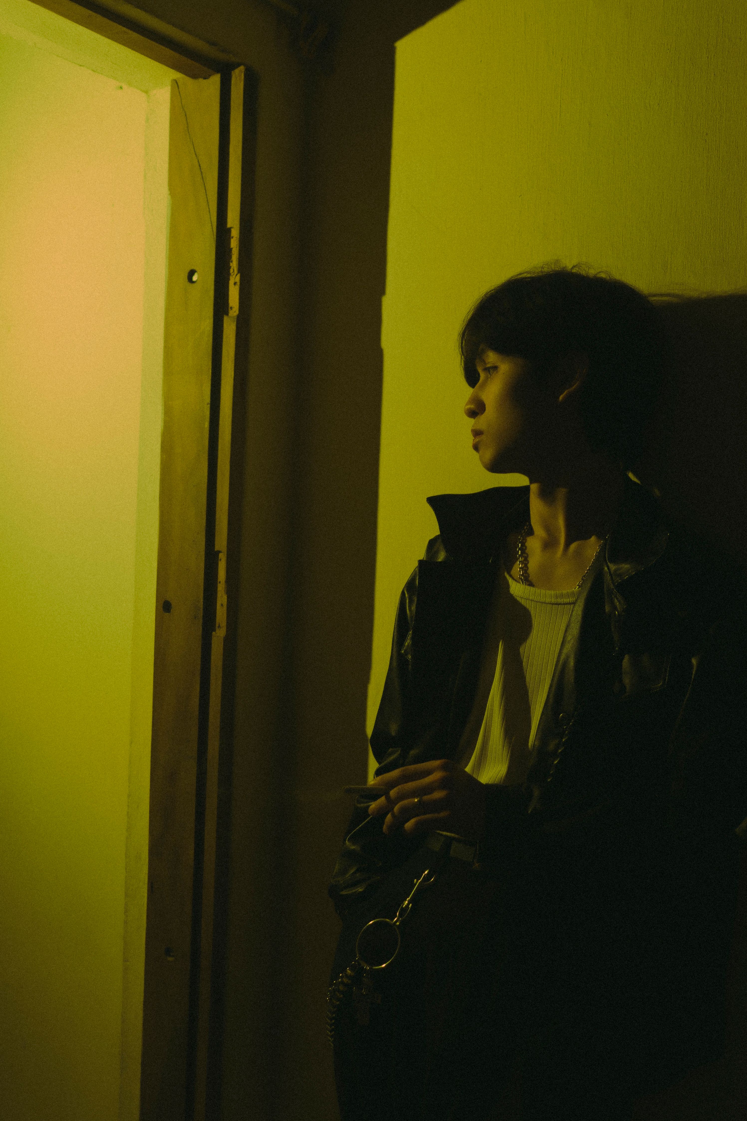 Moody Portrait of Person in Dimly Lit Doorway · Free Stock Photo