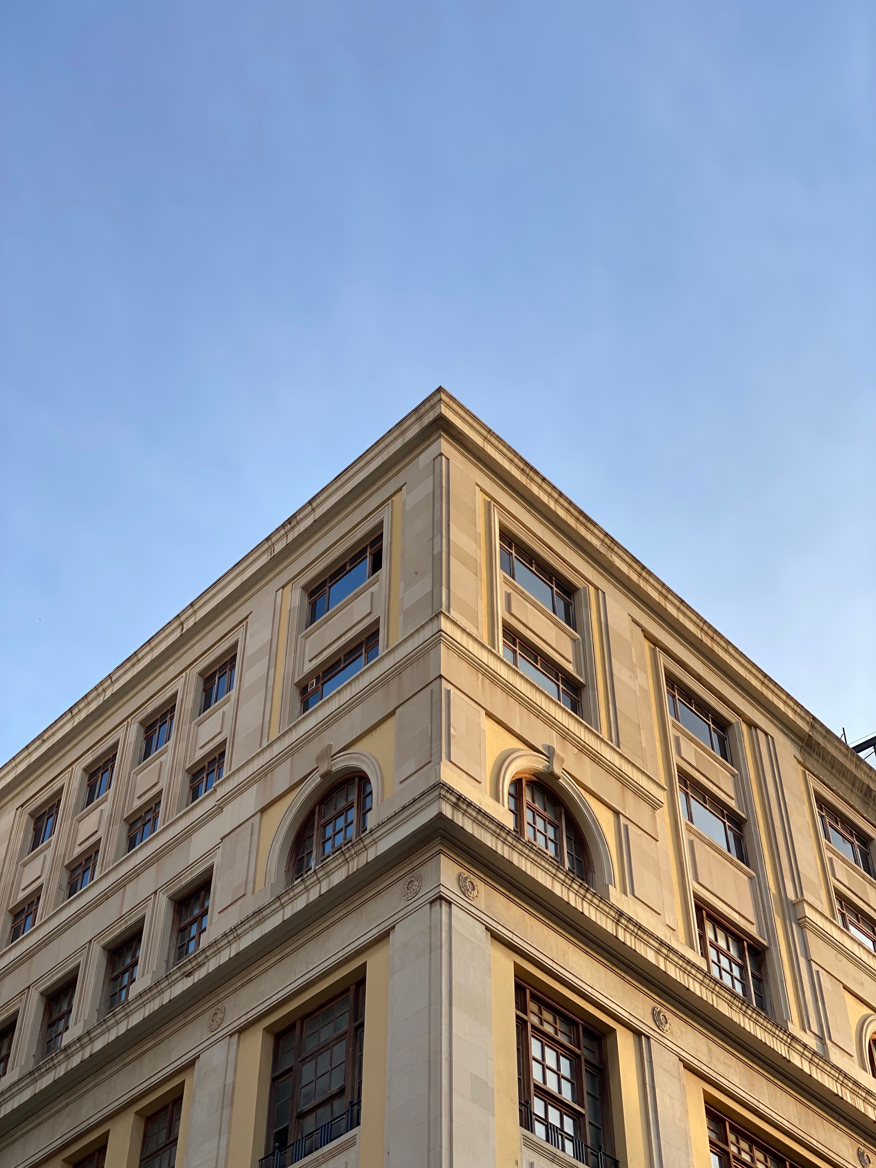 Elegant Corner of Historic Building Under Blue Sky · Free Stock Photo