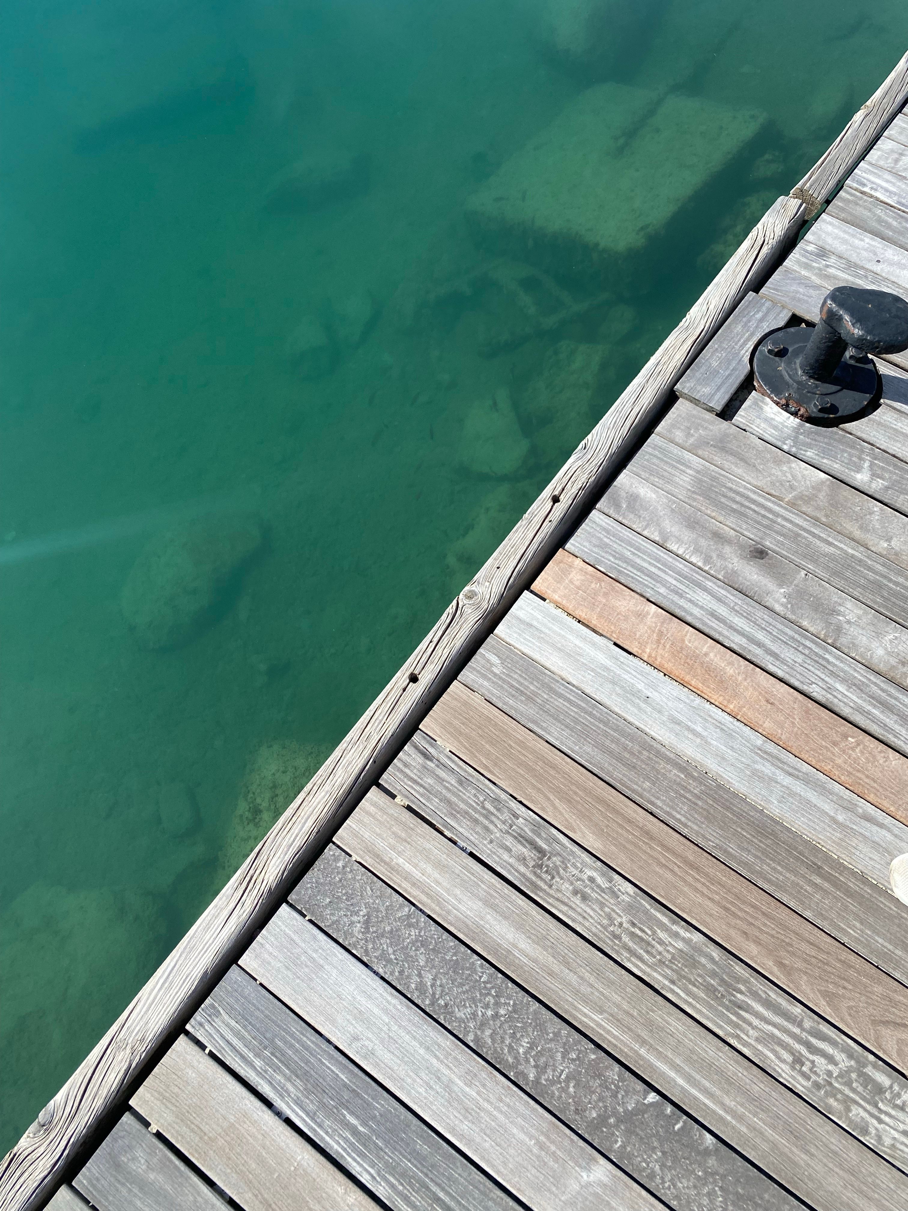 Close-up View of Wooden Dock Over Clear Water · Free Stock Photo