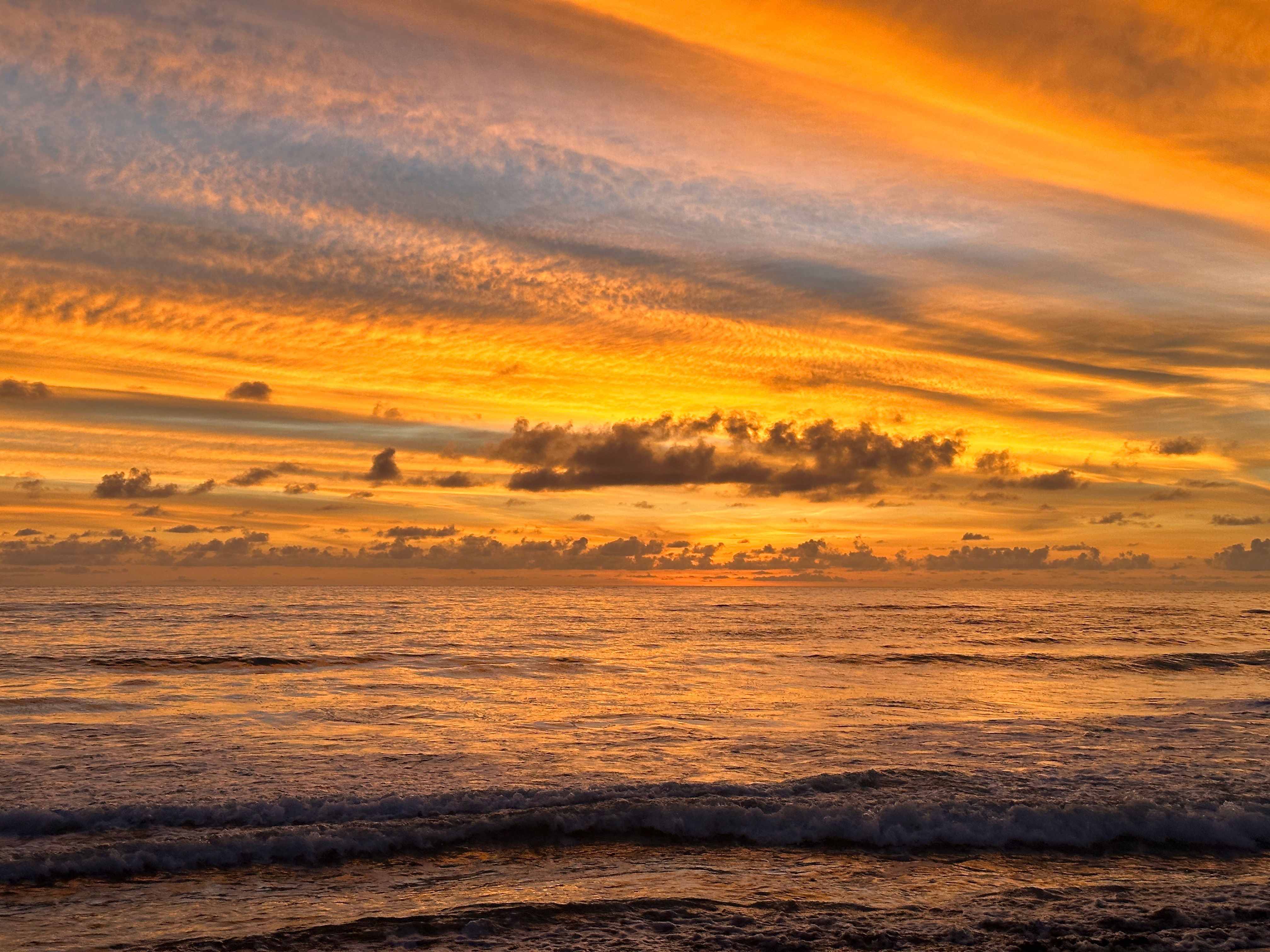 Stunning Sunset Over Calm Ocean Waves · Free Stock Photo