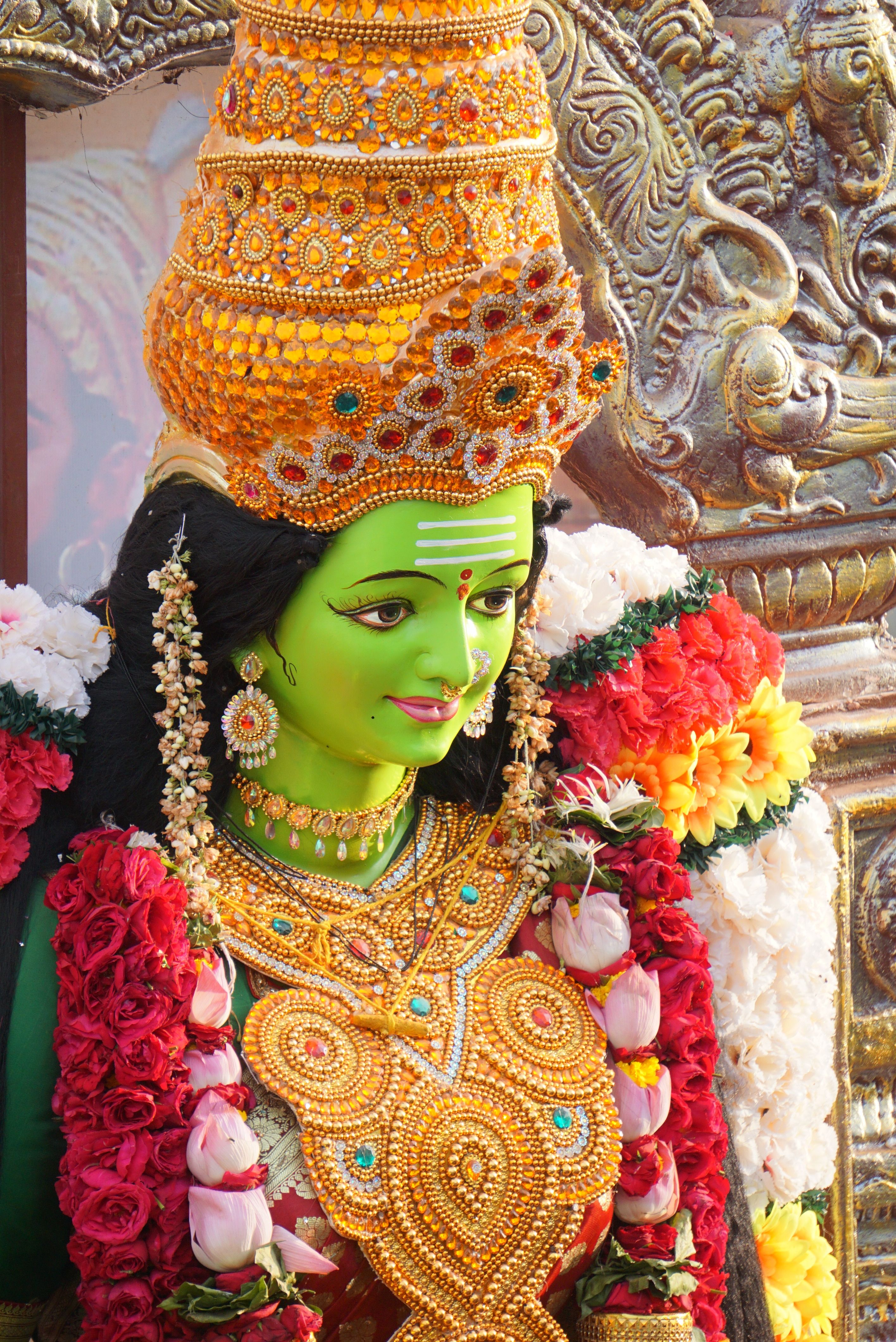 Vibrant Hindu Goddess Statue Decorated with Flowers · Free Stock Photo