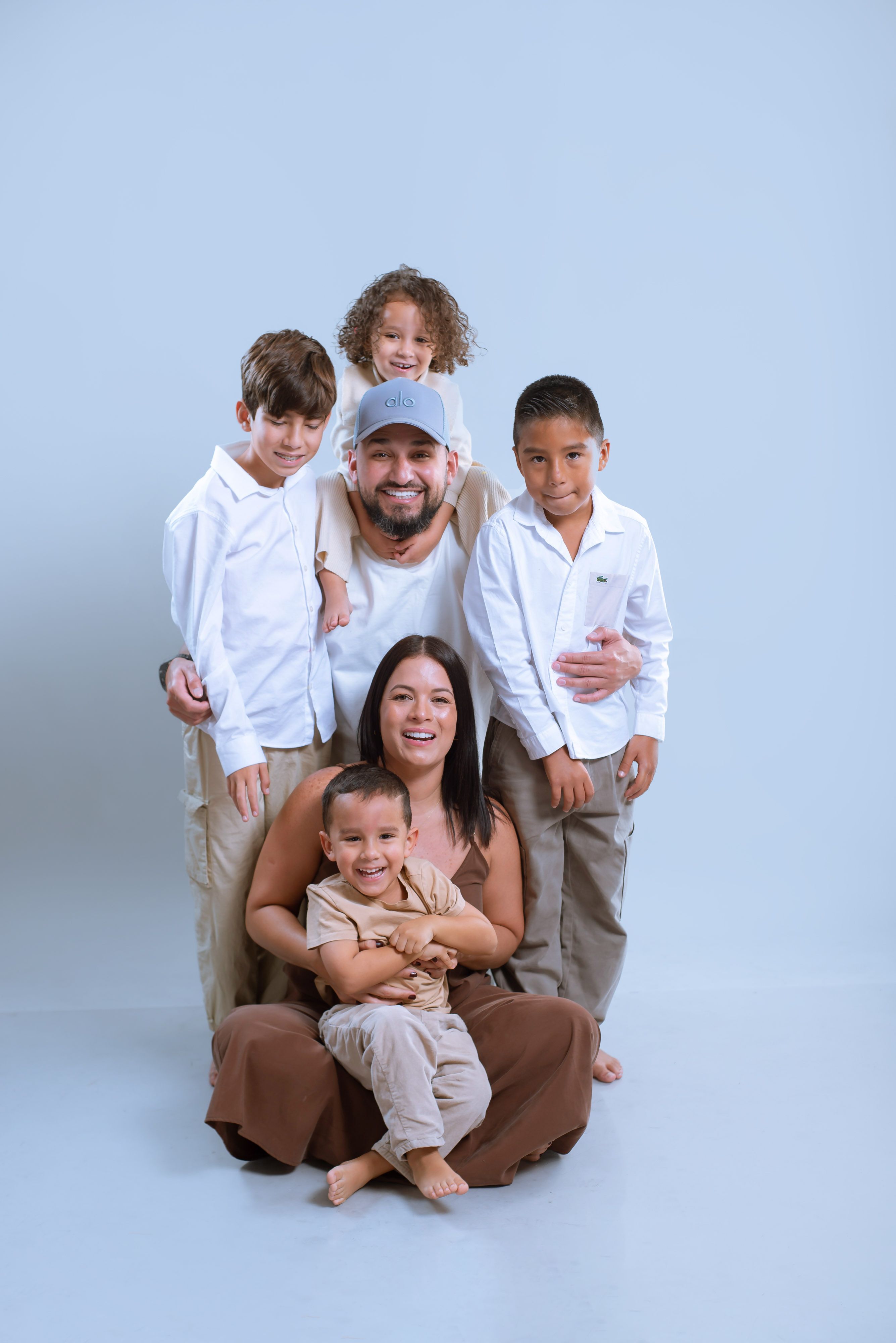 Happy Family Portrait on Light Blue Background · Free Stock Photo