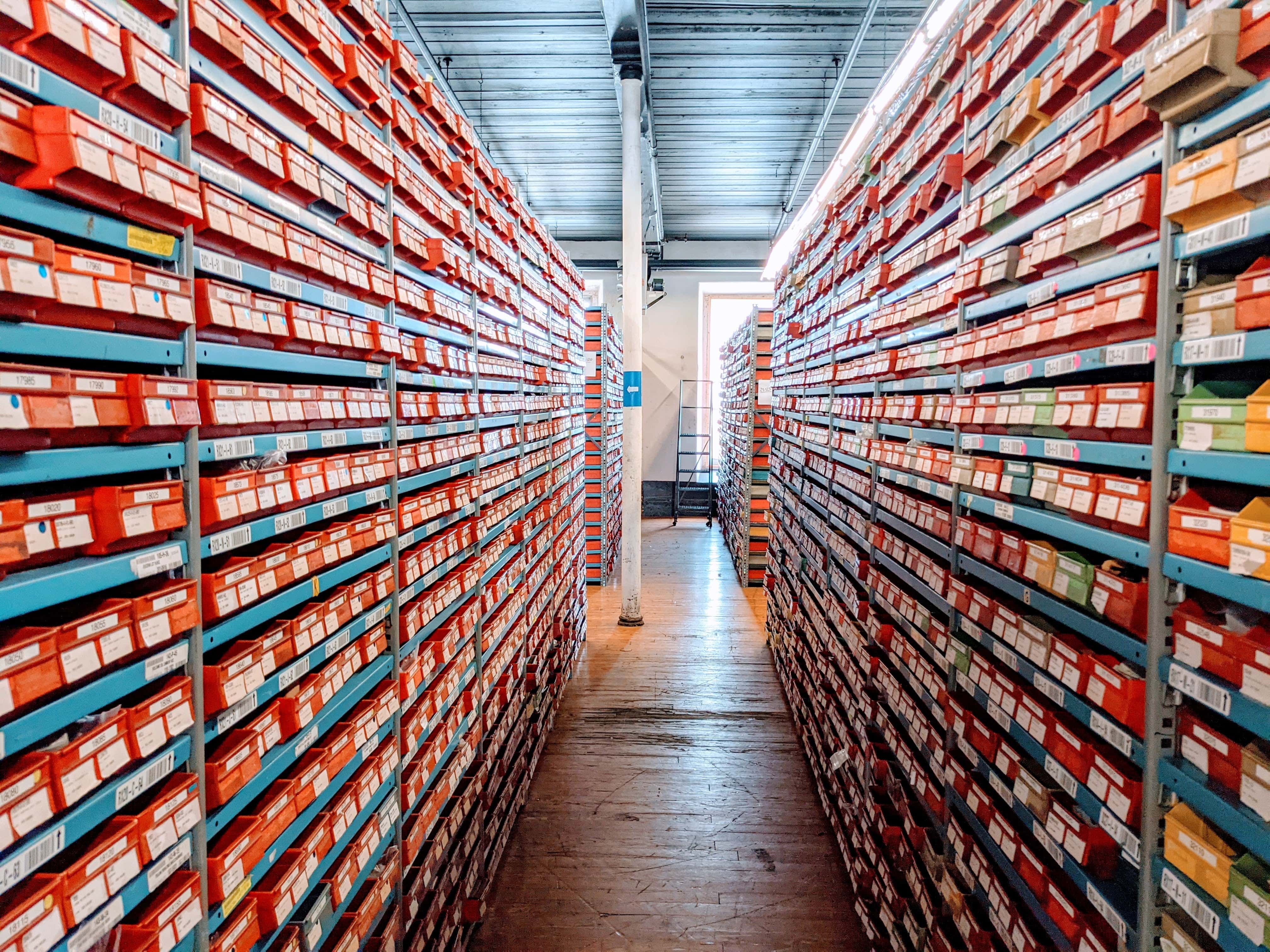 Organized Shoe Storage Aisle in Warehouse · Free Stock Photo