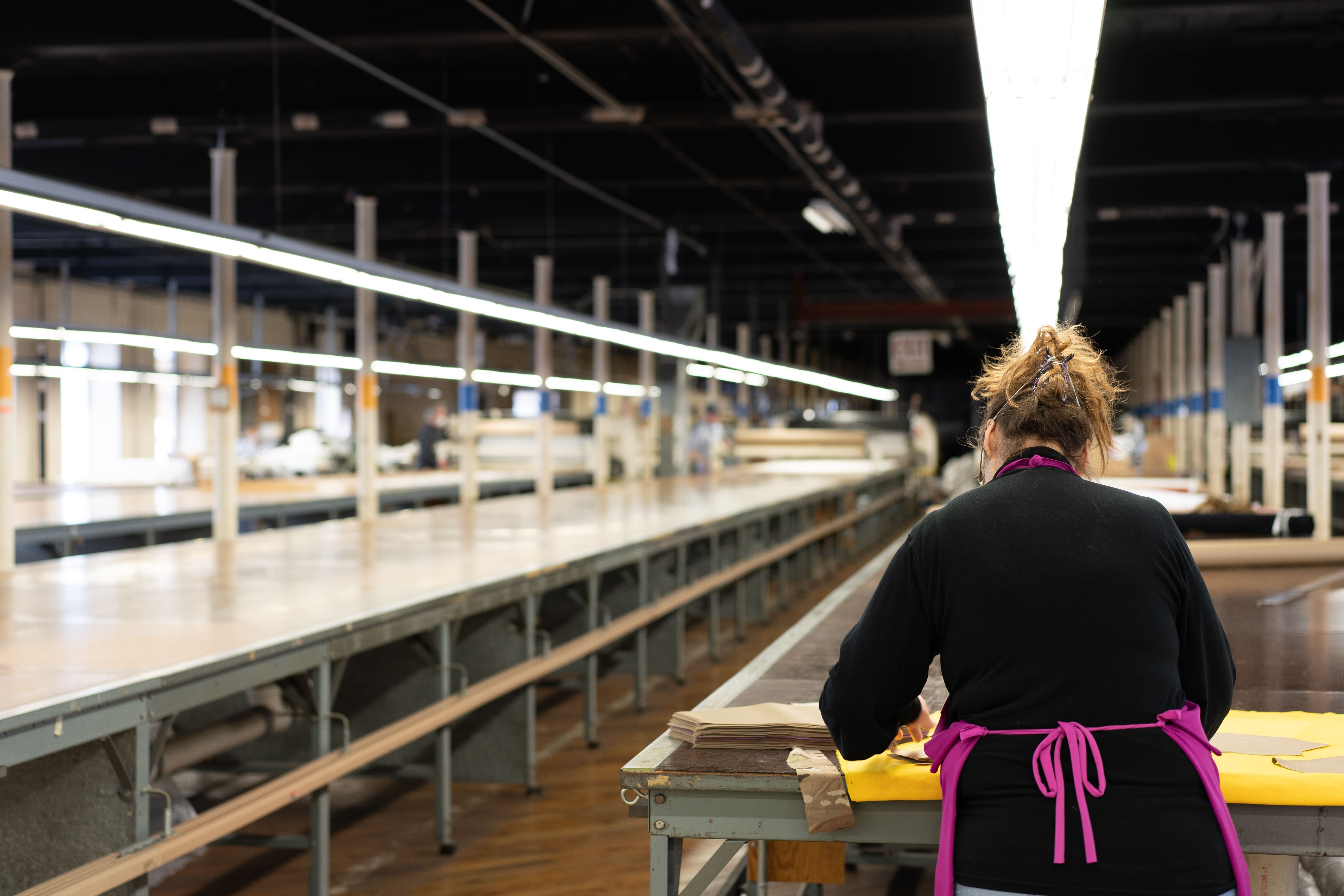 Textile Worker in Factory Setting · Free Stock Photo