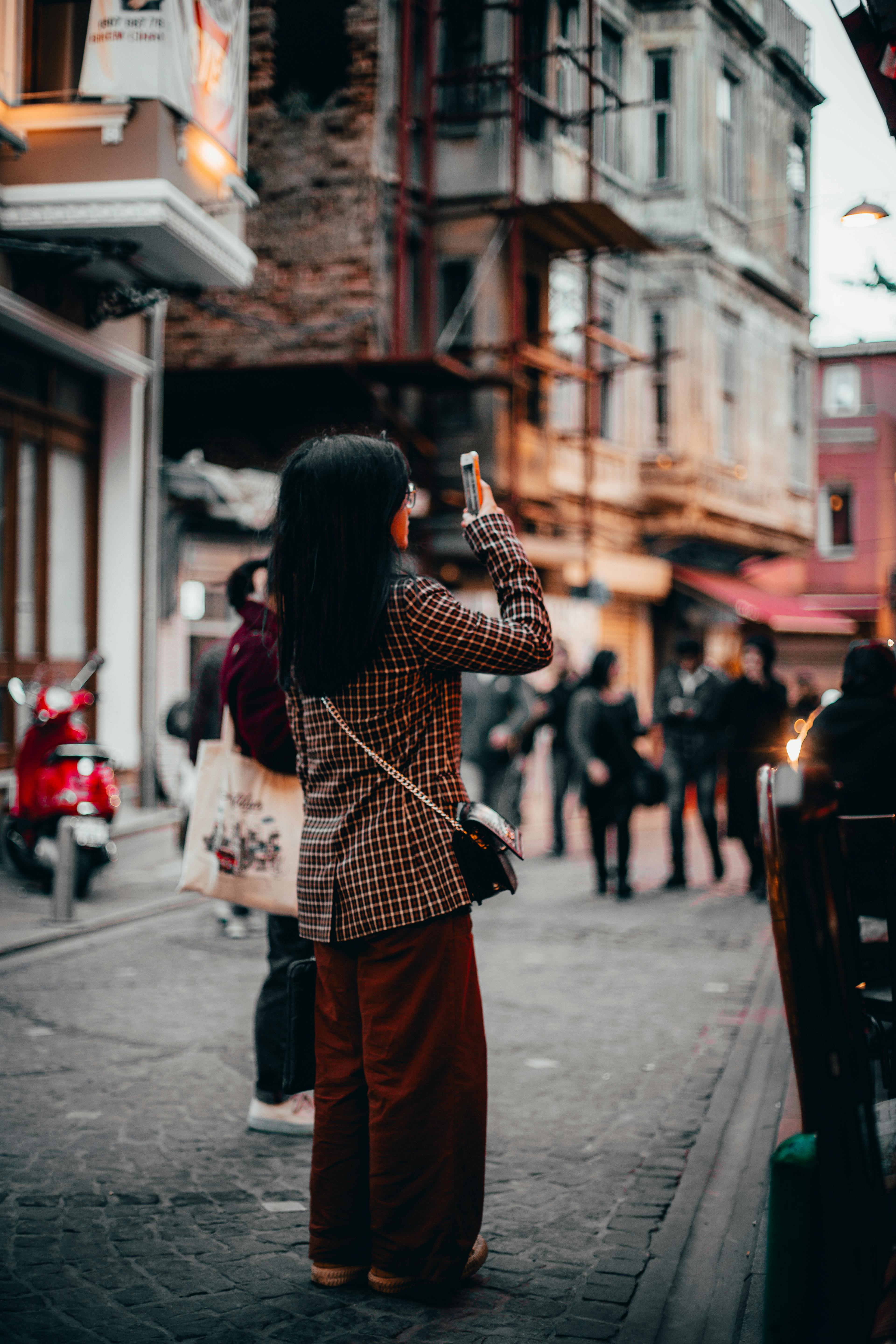 Selective Focus Photography of Woman Taking Photo While Standing on ...