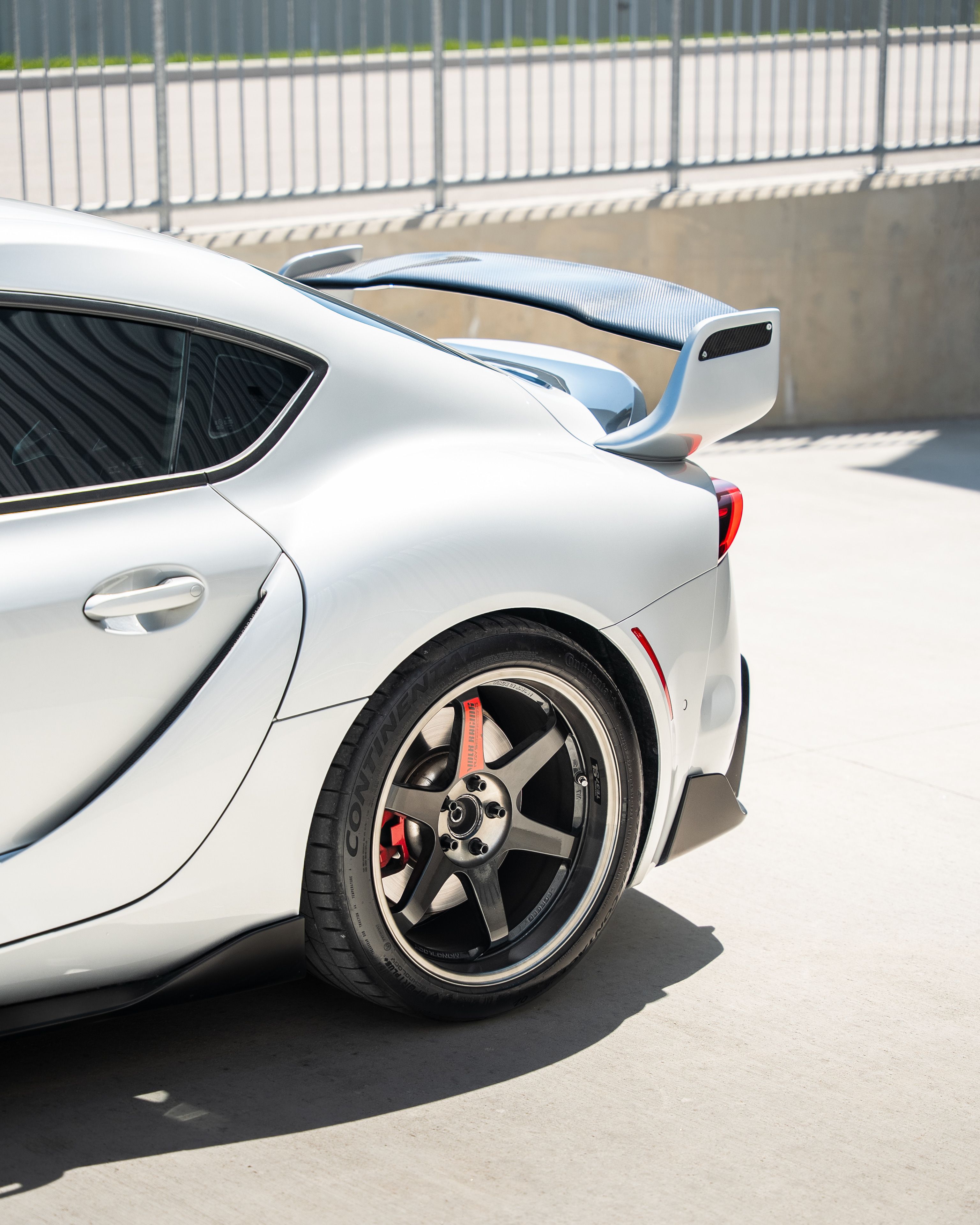 Sporty Silver Car with Spoiler in Sunlight · Free Stock Photo