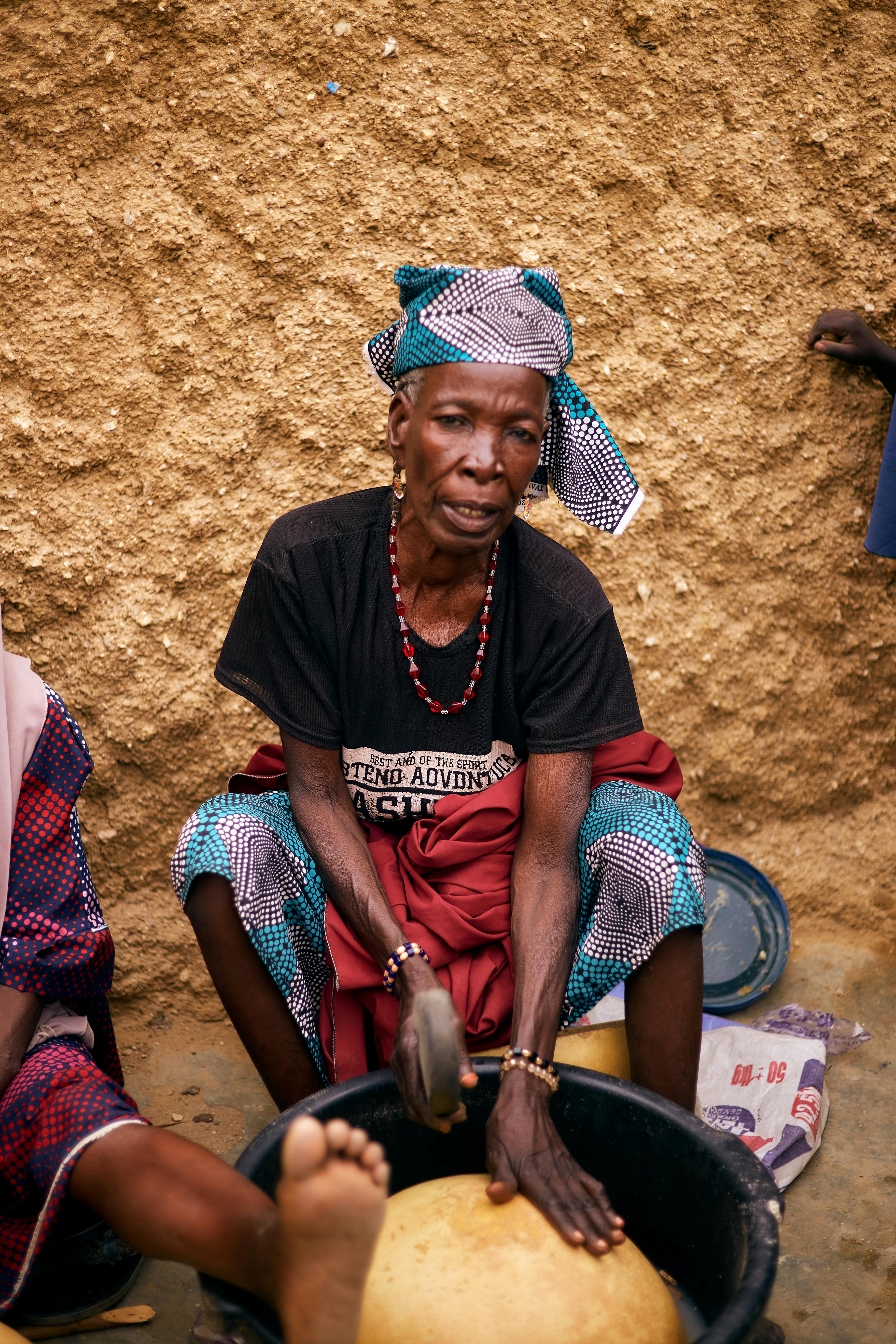 Elderly African Woman Preparing Traditional Food · Free Stock Photo