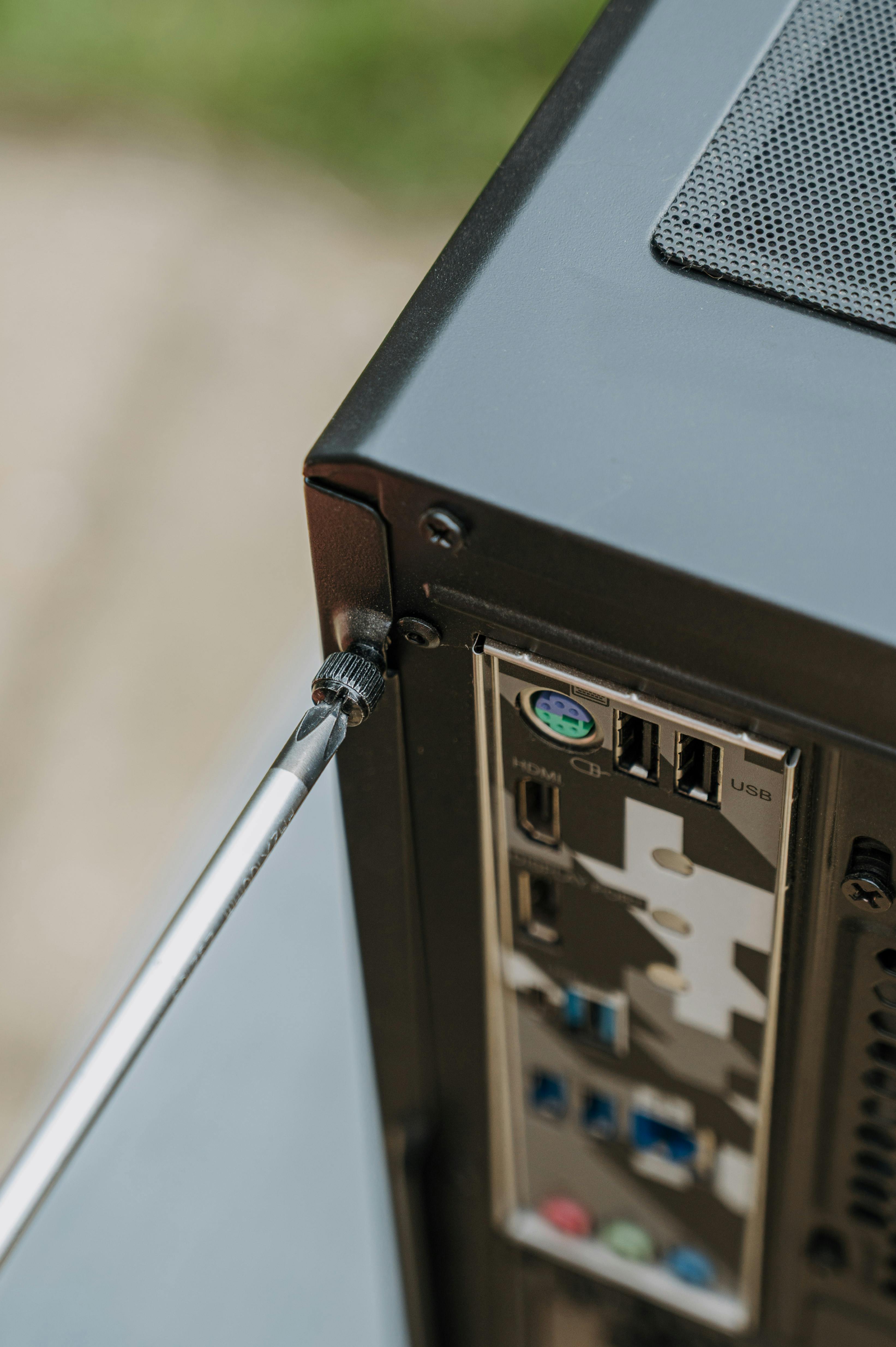 DIY PC Maintenance - Back Panel Unscrewing · Free Stock Photo