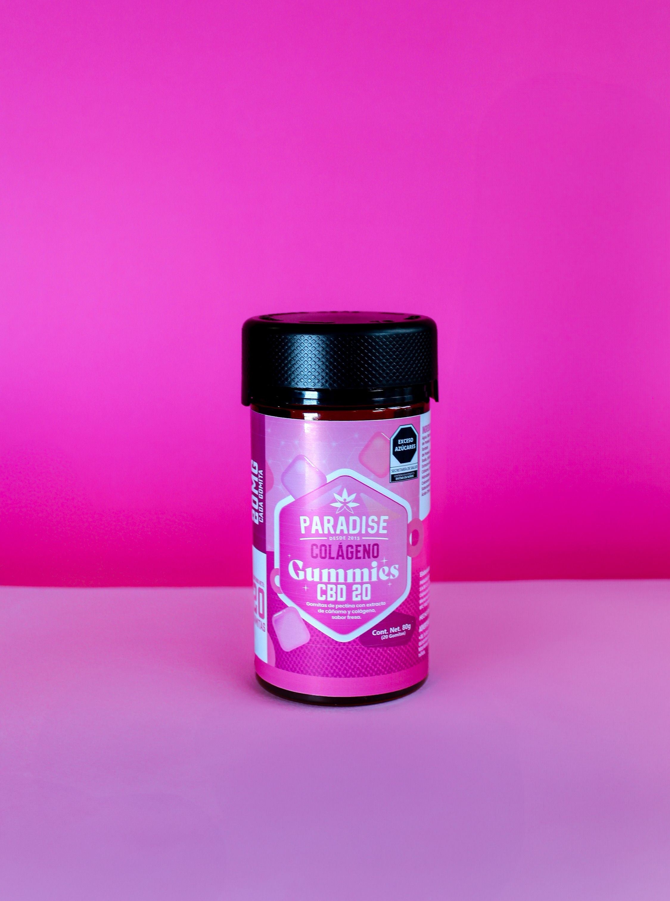 Pink Collagen Gummies CBD Bottle on Vibrant Background · Free Stock Photo