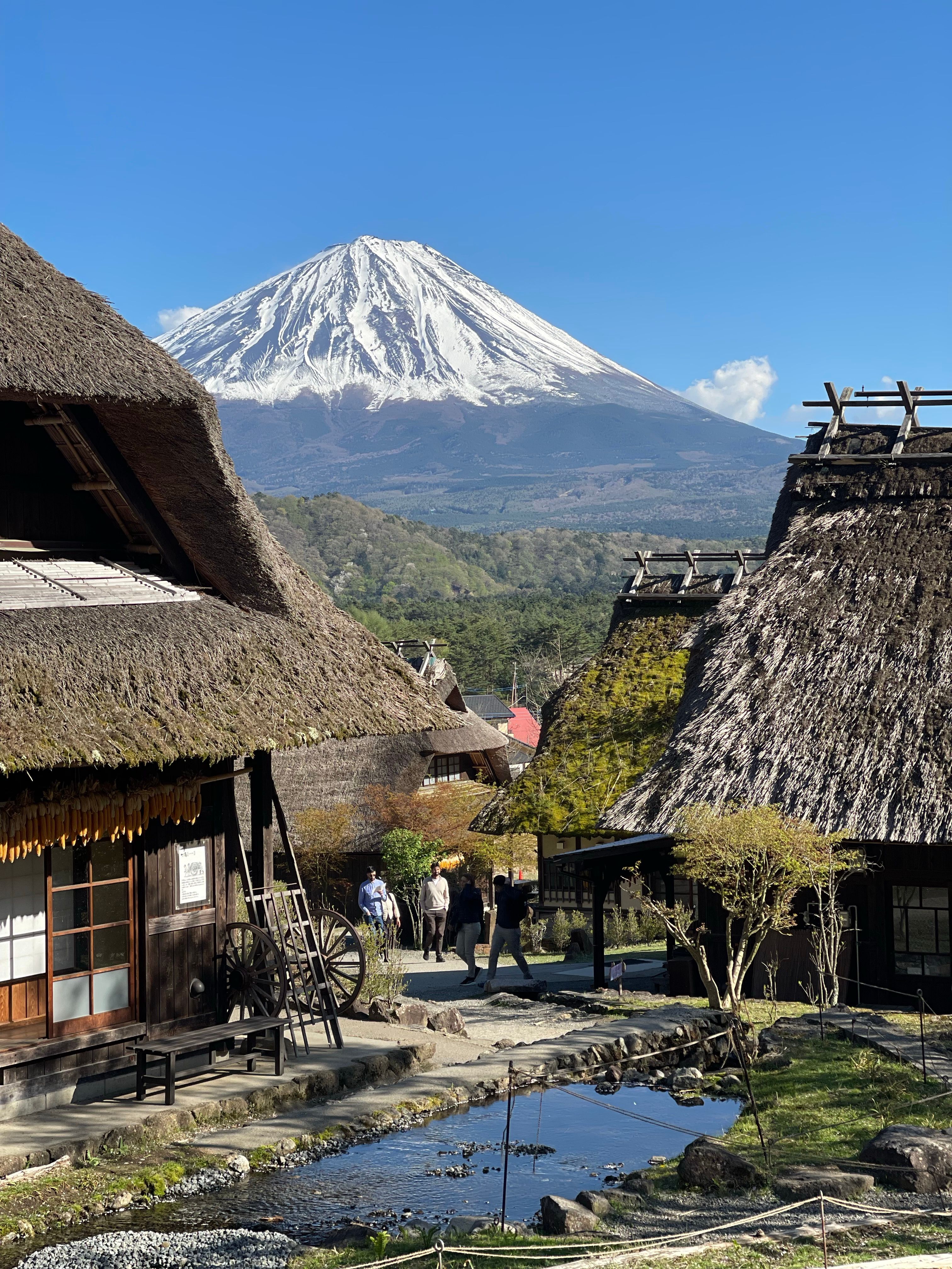 Gray Huts Near Snow-capped Mountain · Free Stock Photo