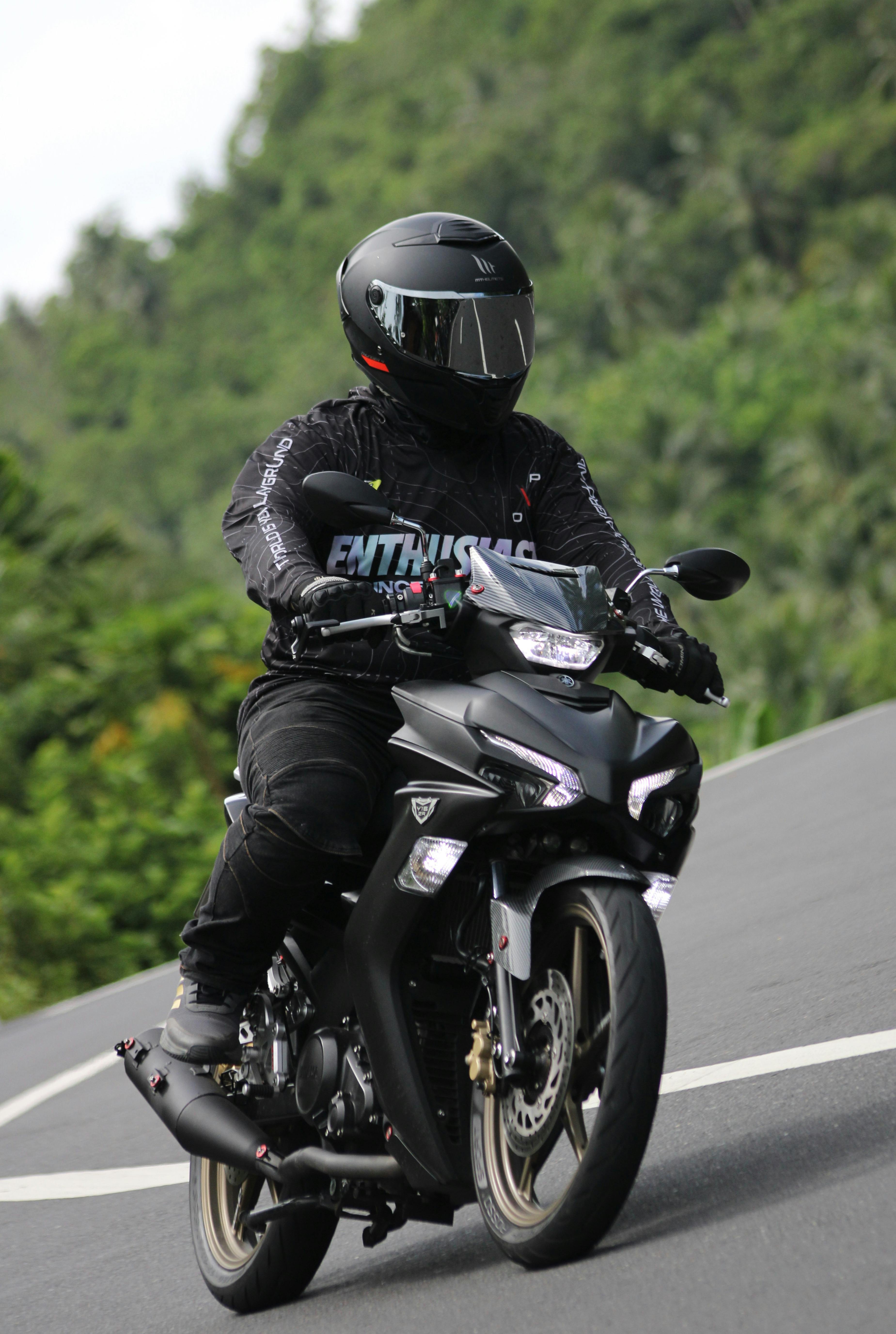 Motorcyclist Riding Through Forest Road · Free Stock Photo