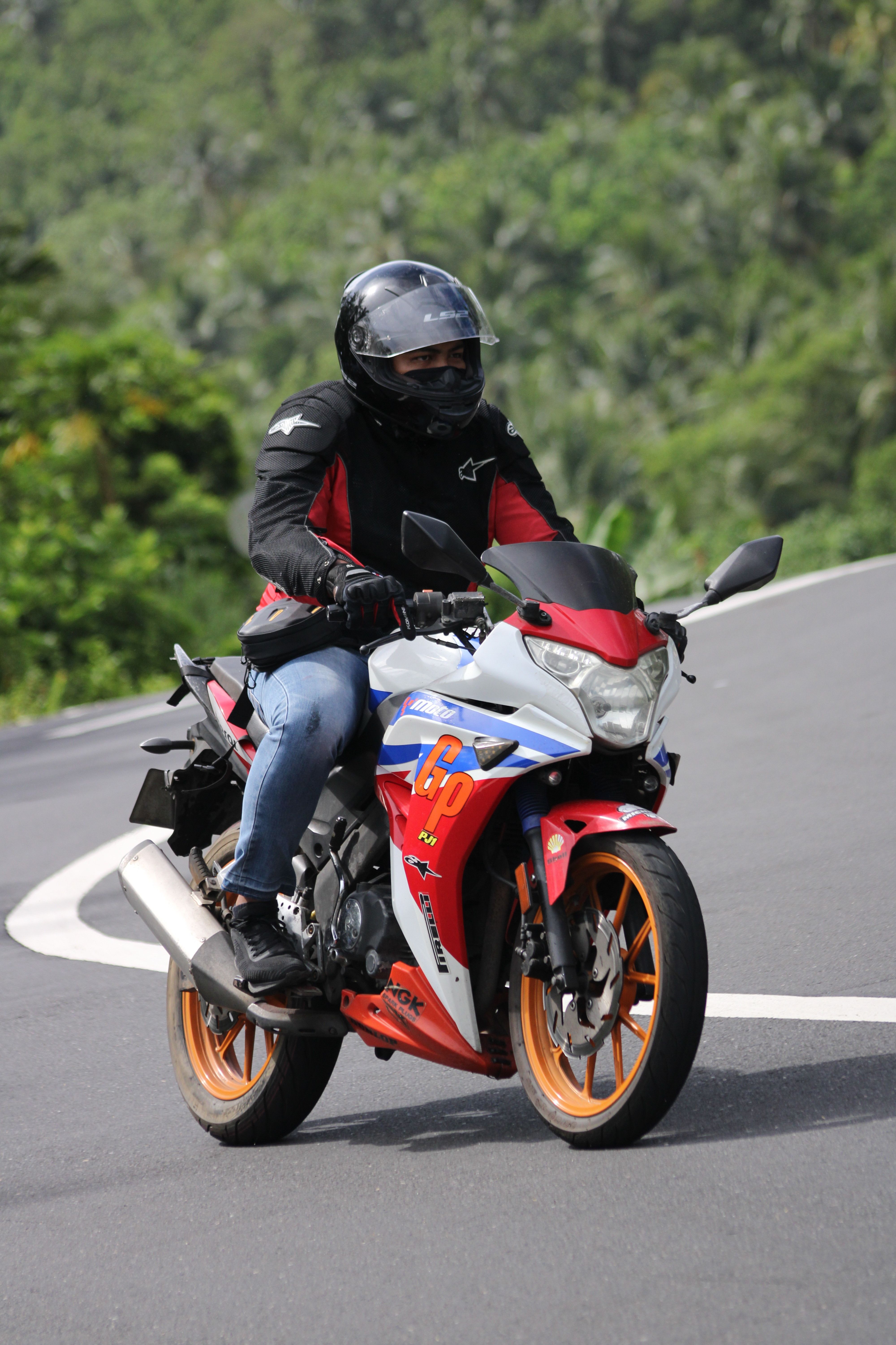 Motorcyclist Riding Sport Bike on Curvy Road · Free Stock Photo