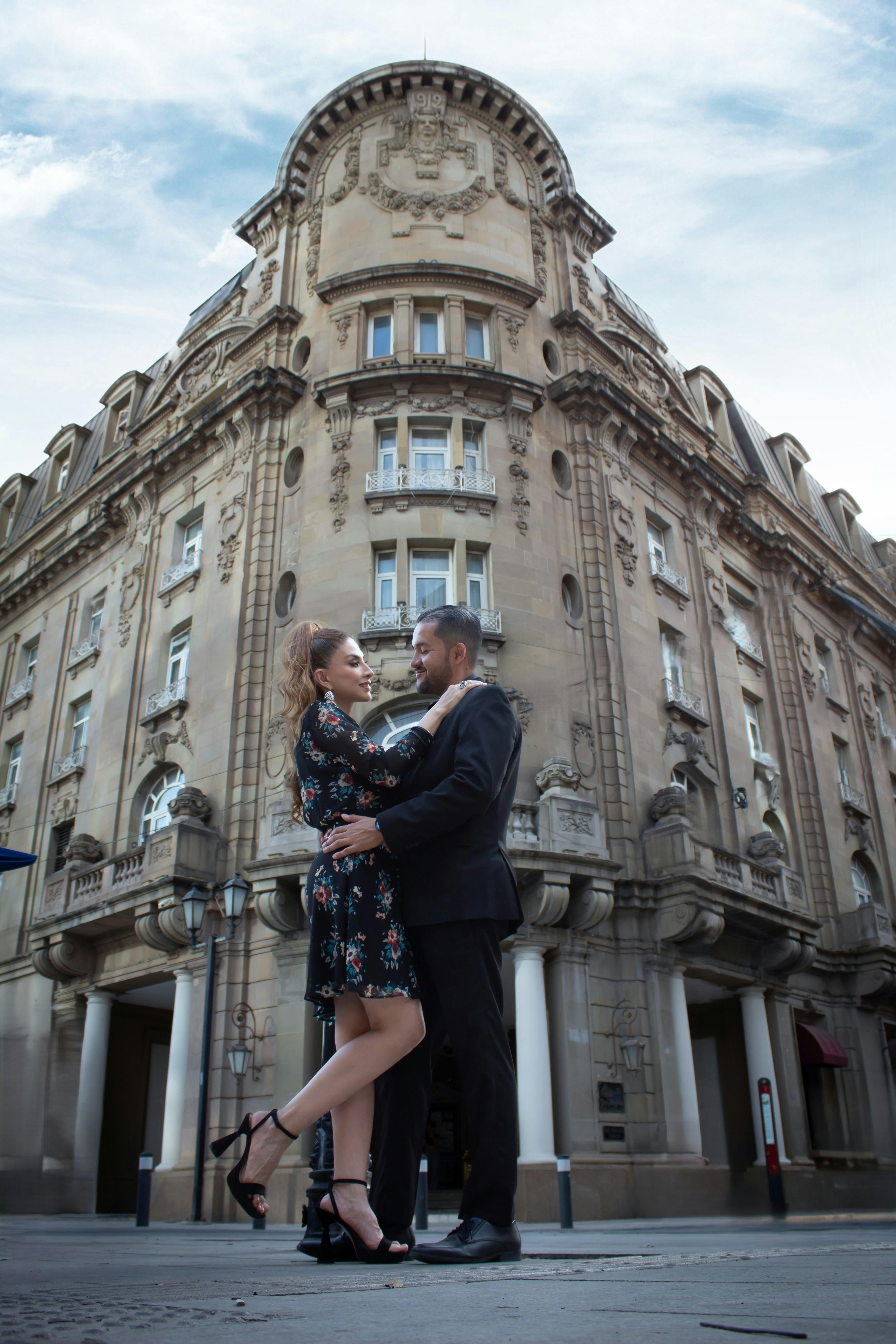 Romantic Couple Embracing Near Historic Building · Free Stock Photo