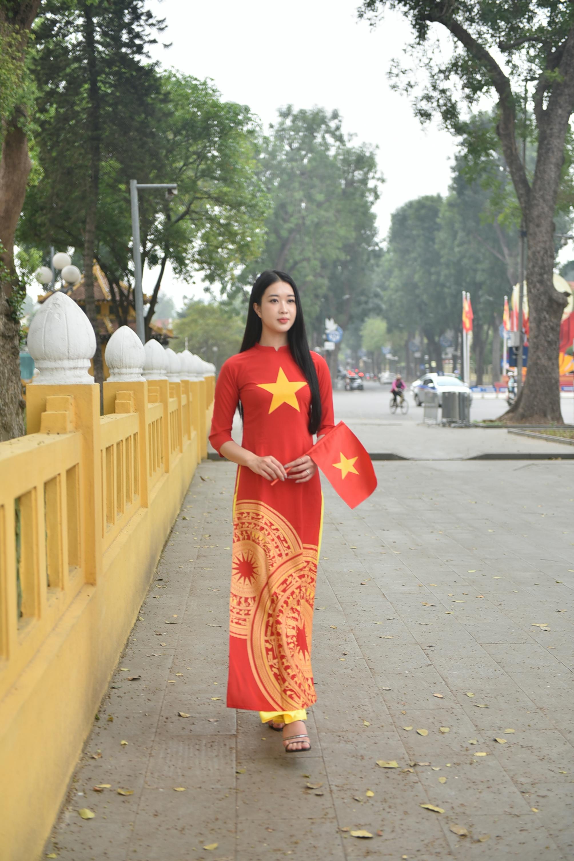 Elegant Woman in Traditional Ao Dai with Flag · Free Stock Photo