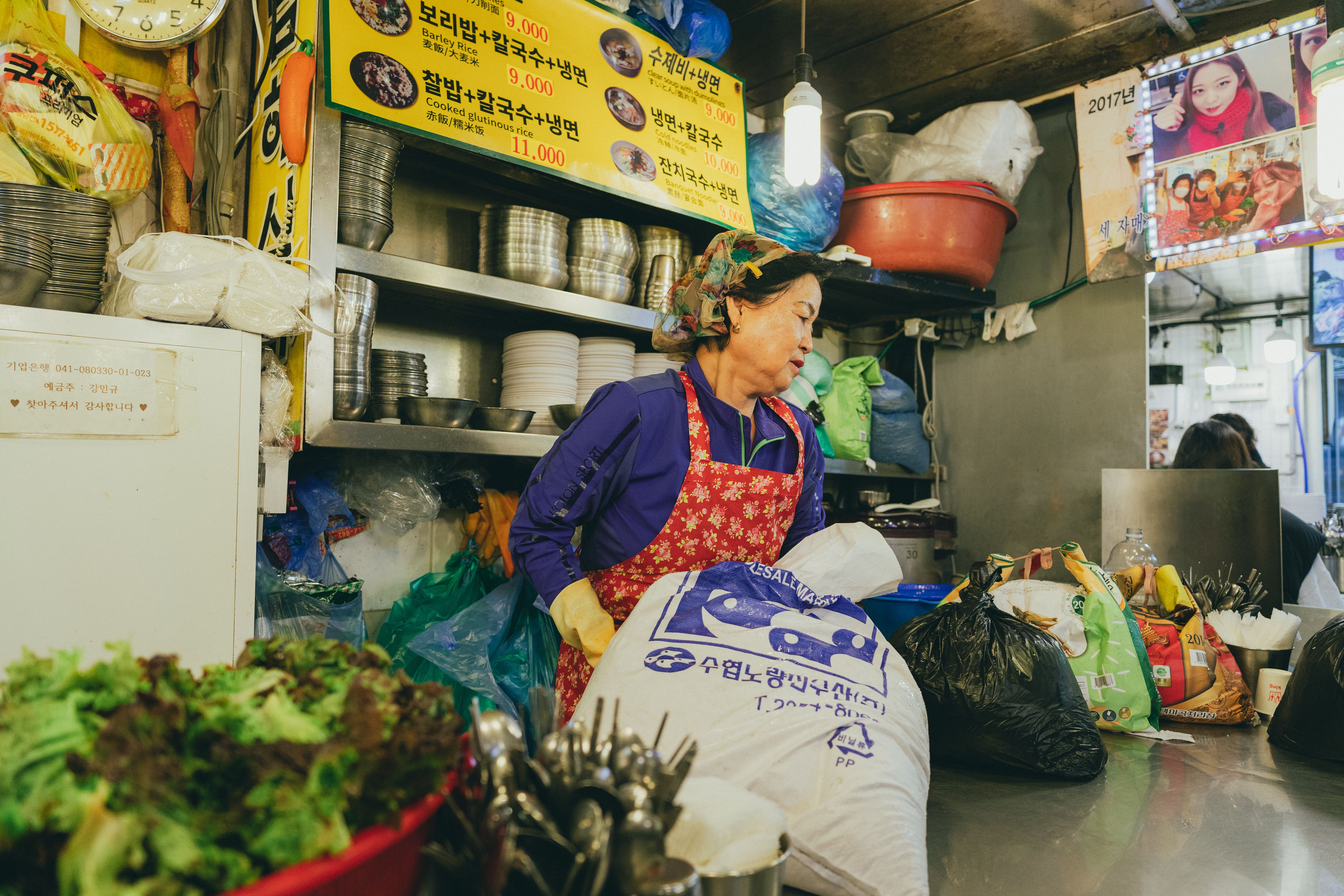 Traditional Korean Market Vendor at Her Stall · Free Stock Photo