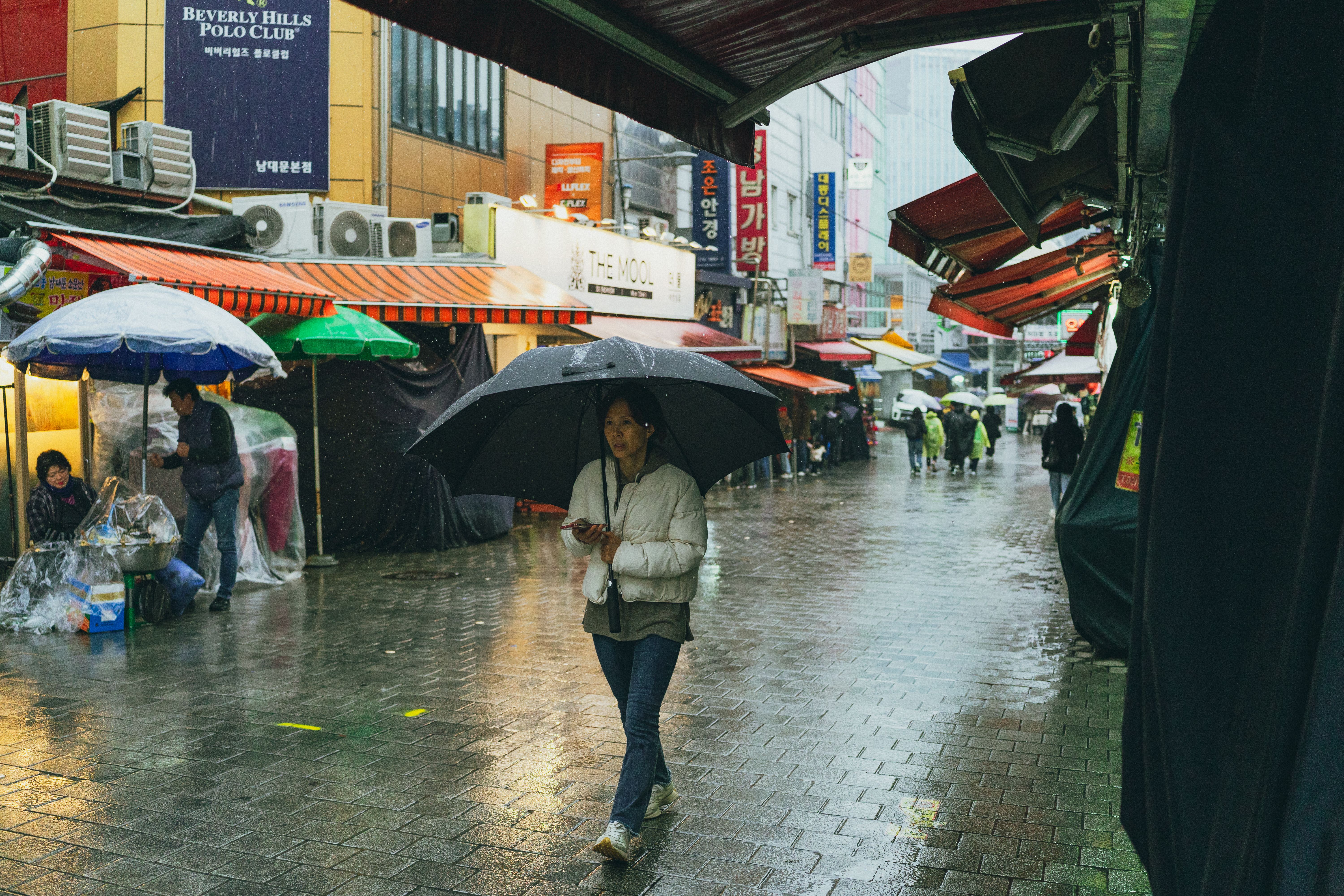 Person Walking on Market · Free Stock Photo