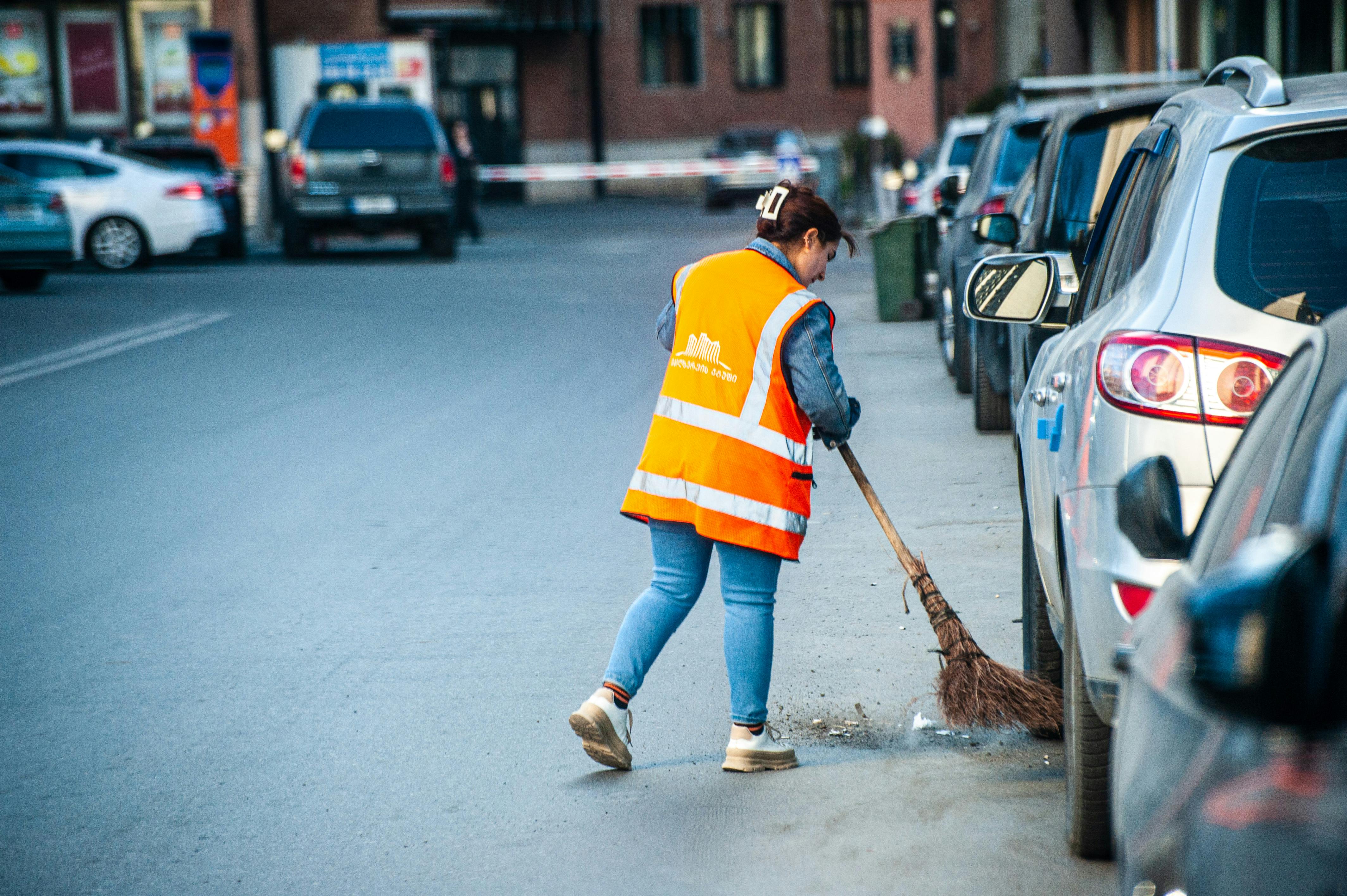 Street Cleaner in Tbilisi Sweeping Roadside · Free Stock Photo