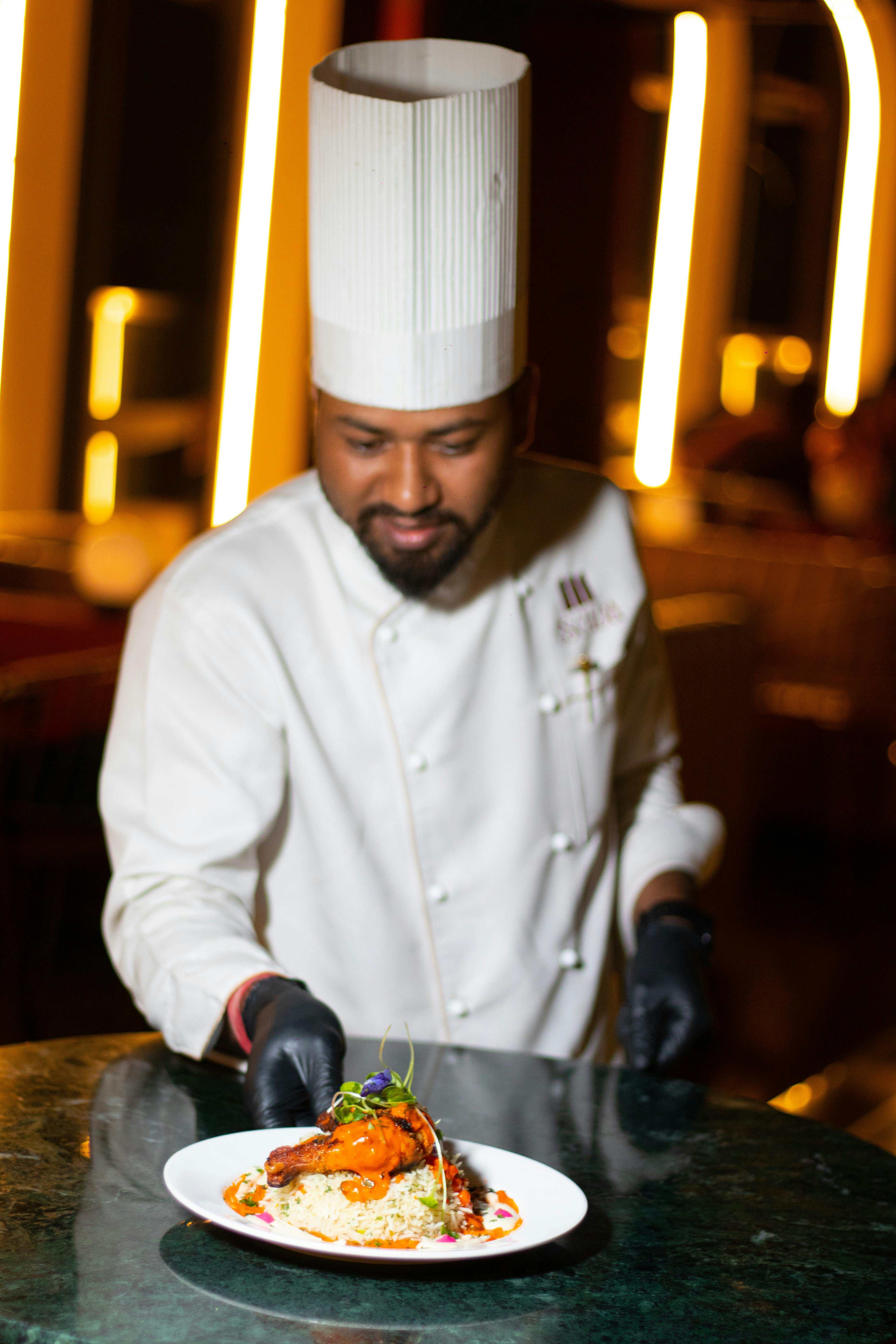 Chef Precisely Plating a Dish in Modern Kitchen · Free Stock Photo