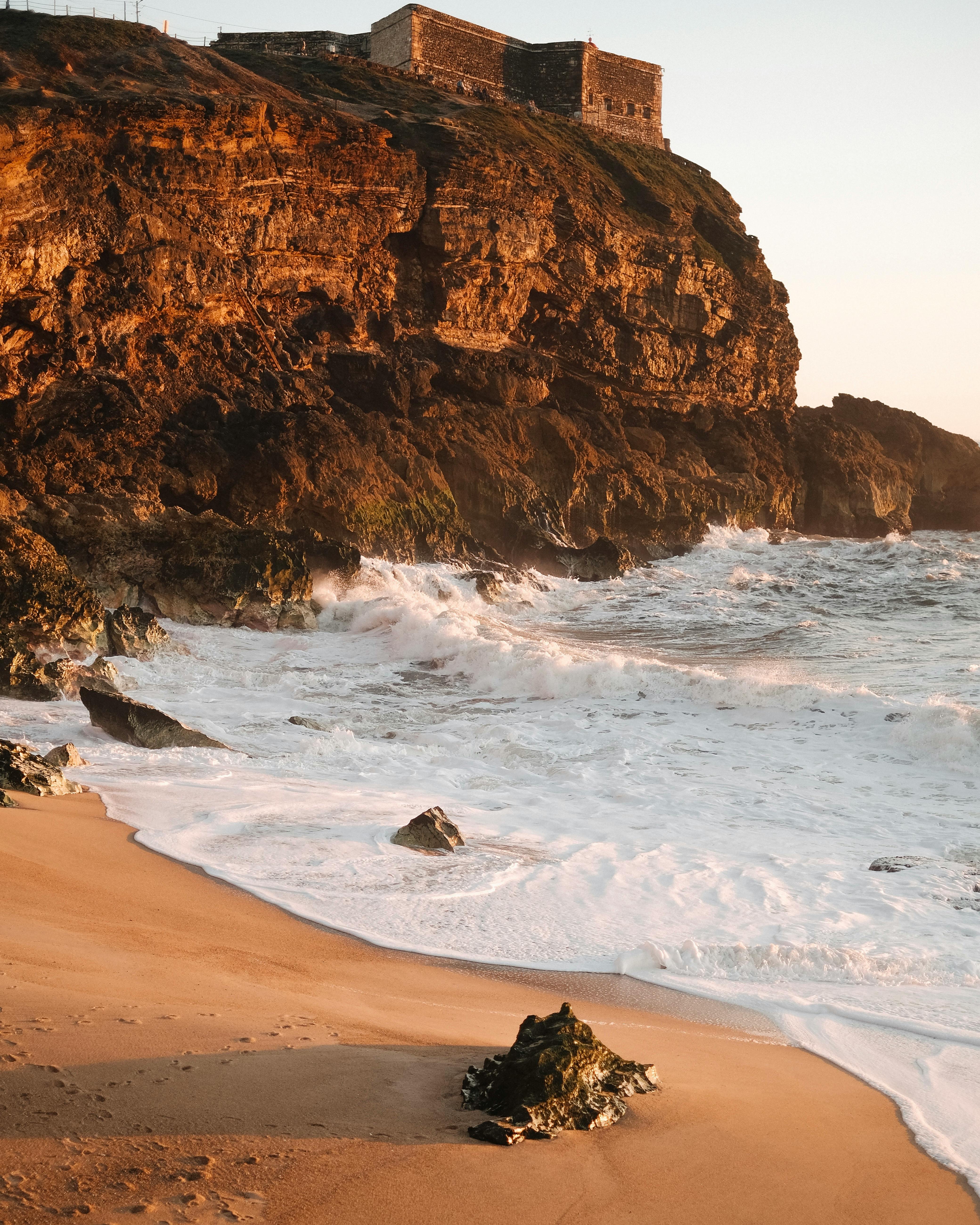 Dramatic Cliffside Fortress Overlooking Ocean Waves · Free Stock Photo