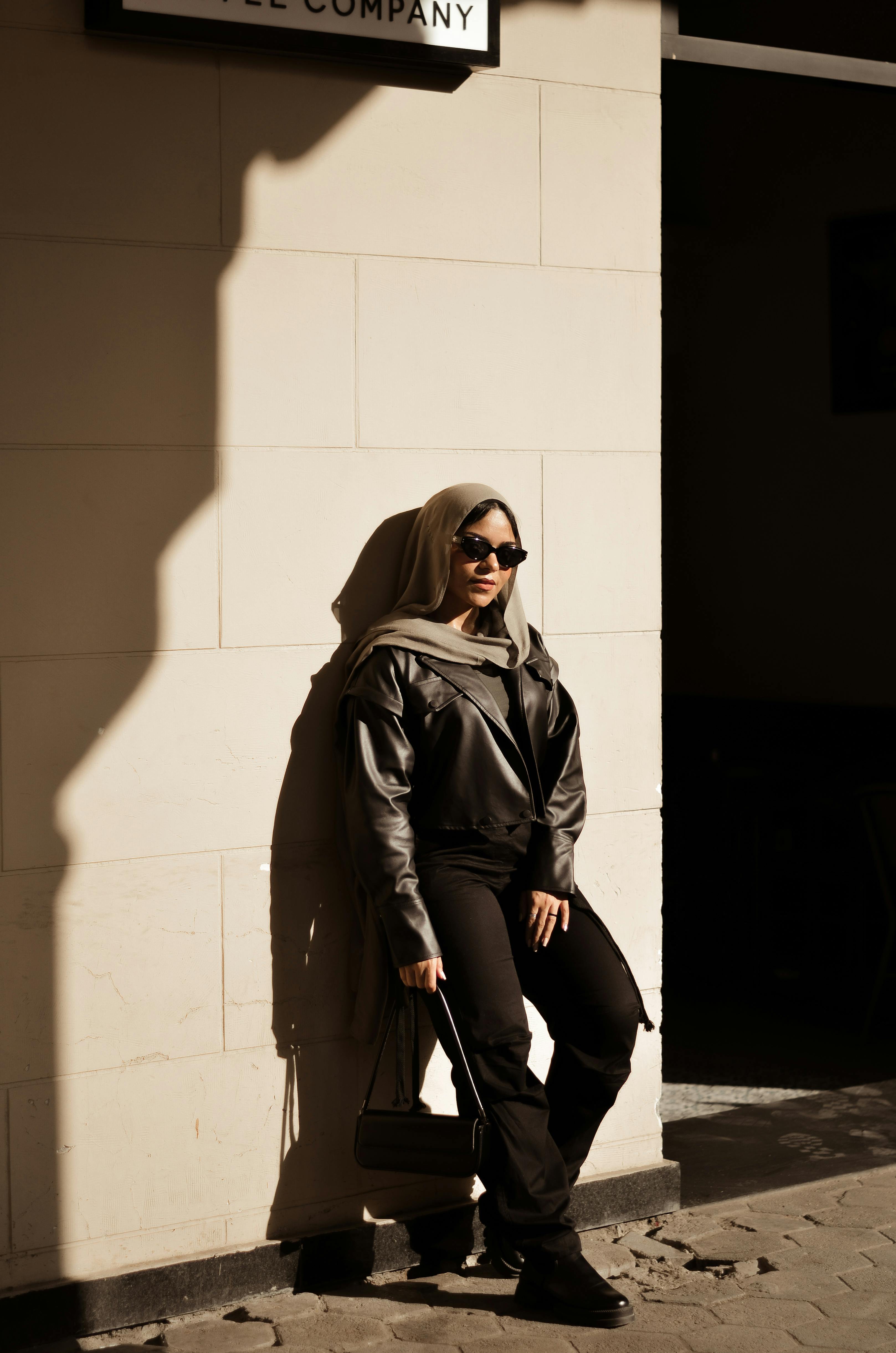 Chic Woman in Hijab Posing Against Wall in Cairo · Free Stock Photo