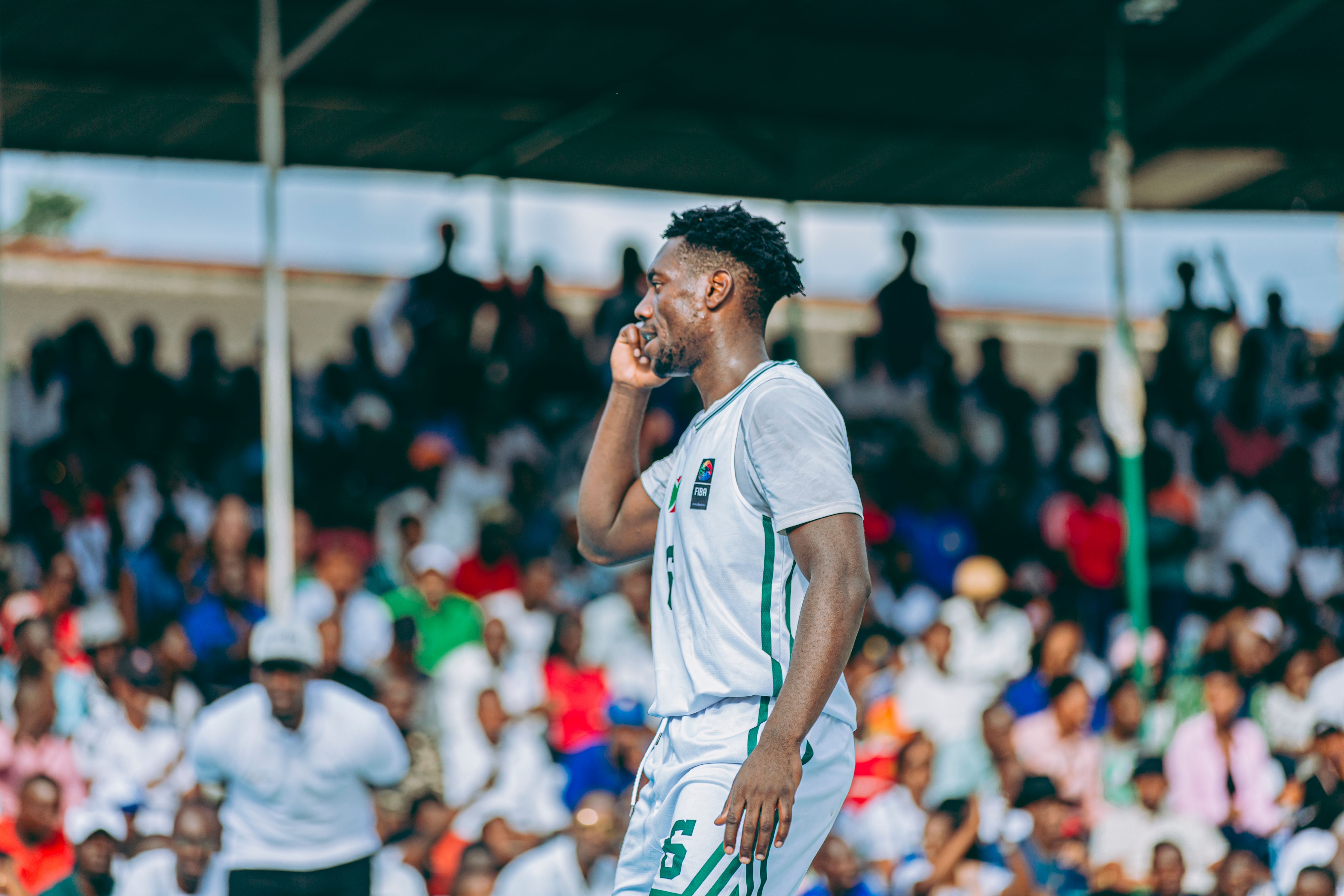 Basketball Player Celebrating with Crowd Outdoors · Free Stock Photo