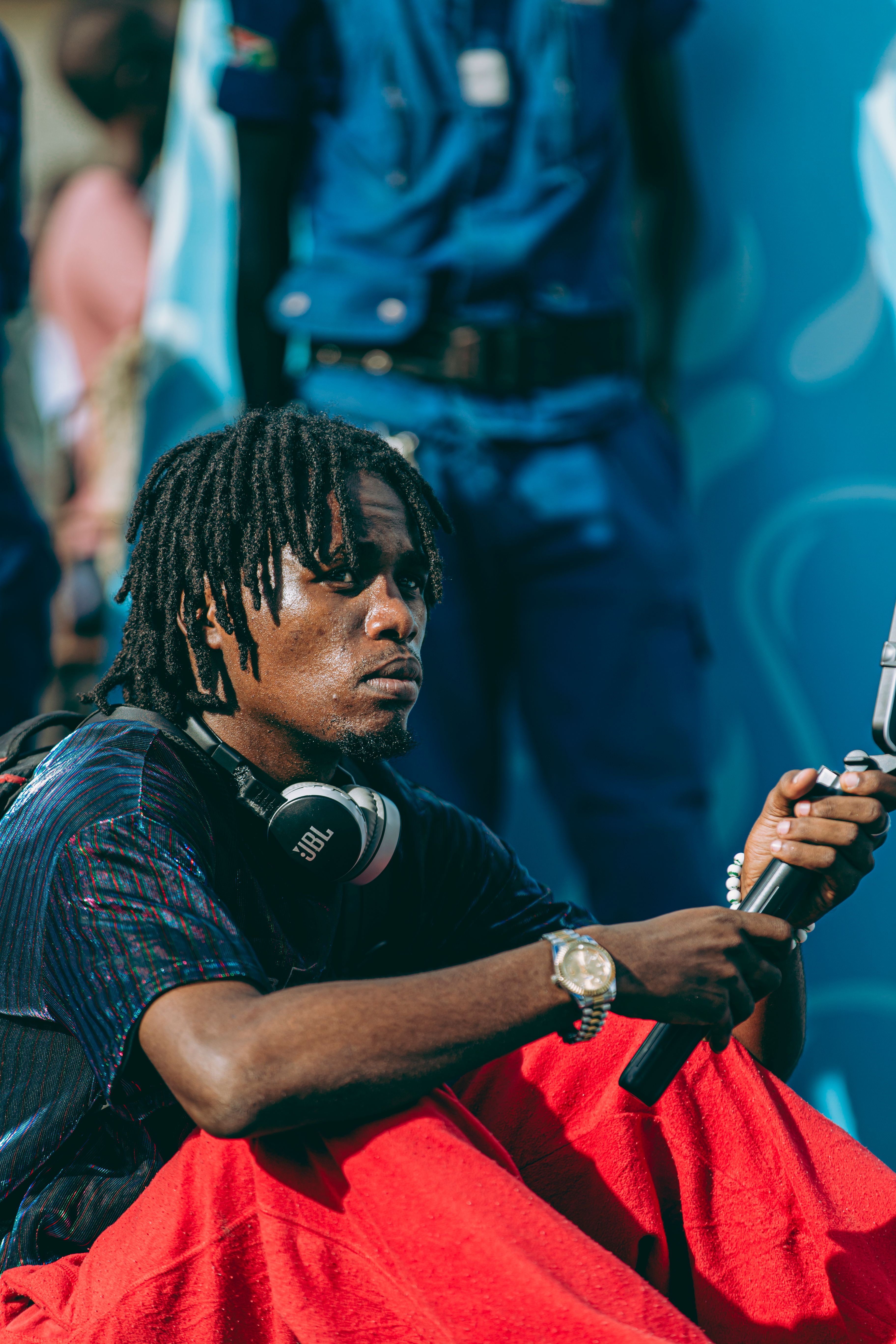 Musician with Dreadlocks Sitting Outdoors · Free Stock Photo