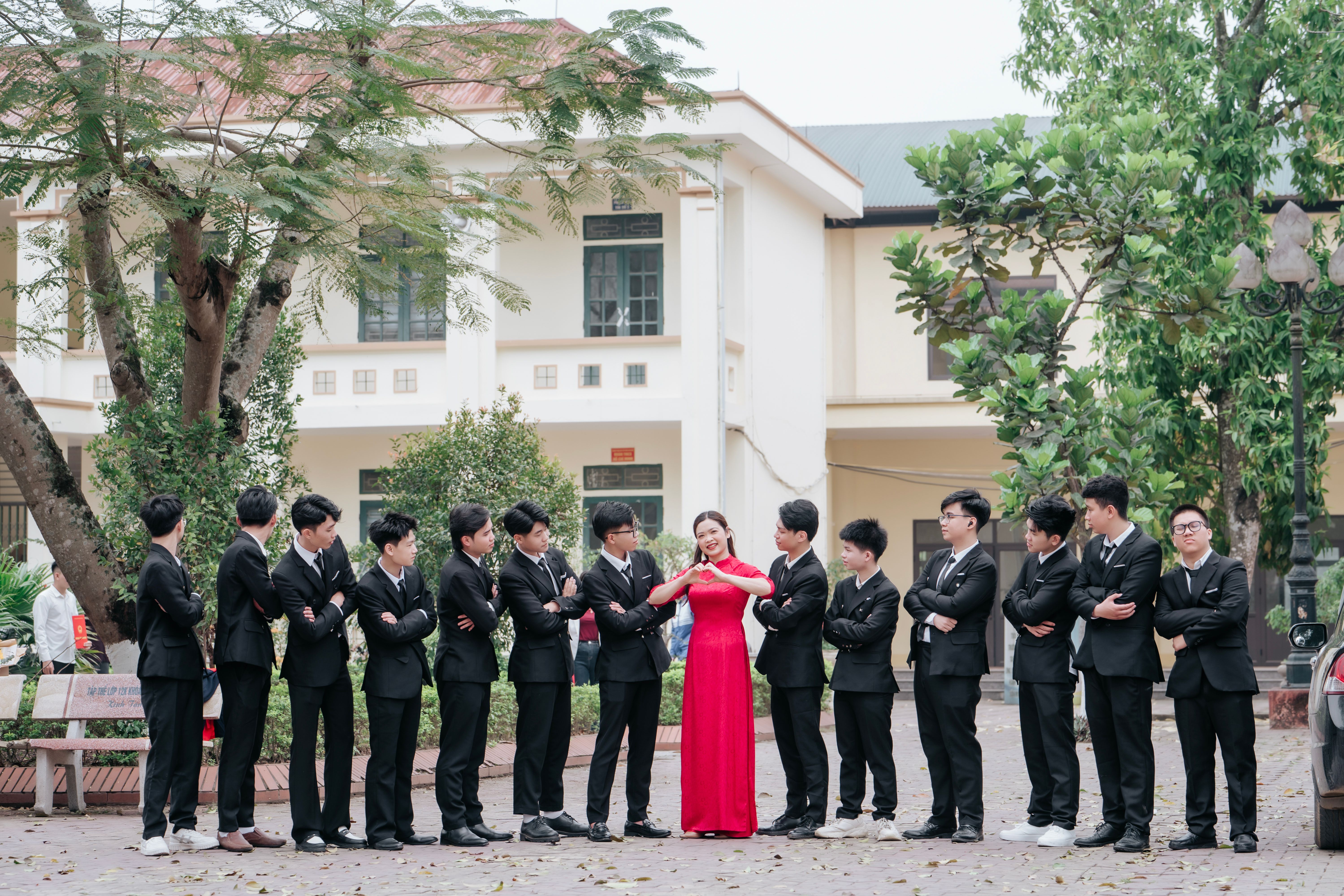 Young Adults Posing in Formal Attire Outdoors · Free Stock Photo