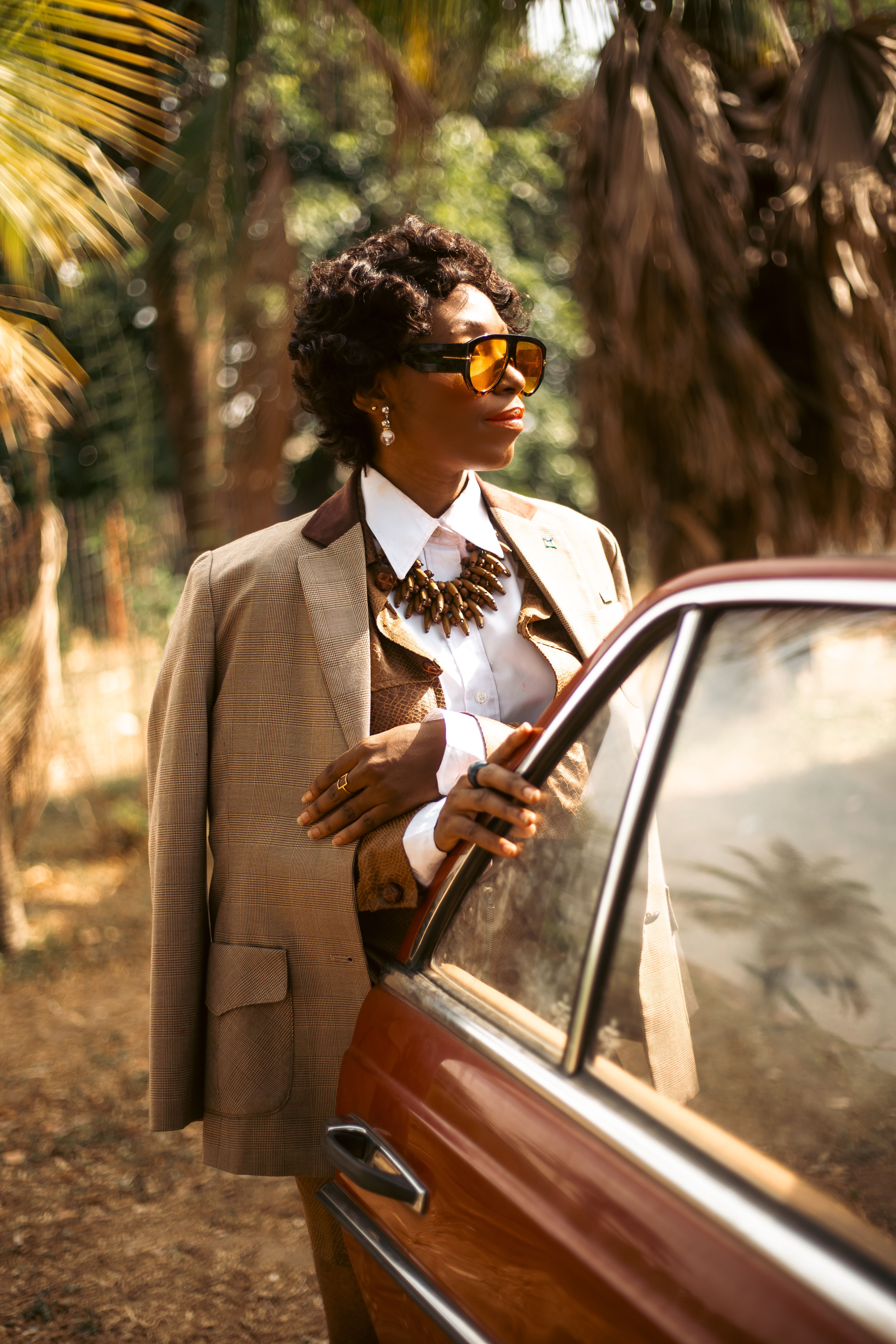 Stylish Woman in Chic Suit with Classic Car Outdoors · Free Stock Photo