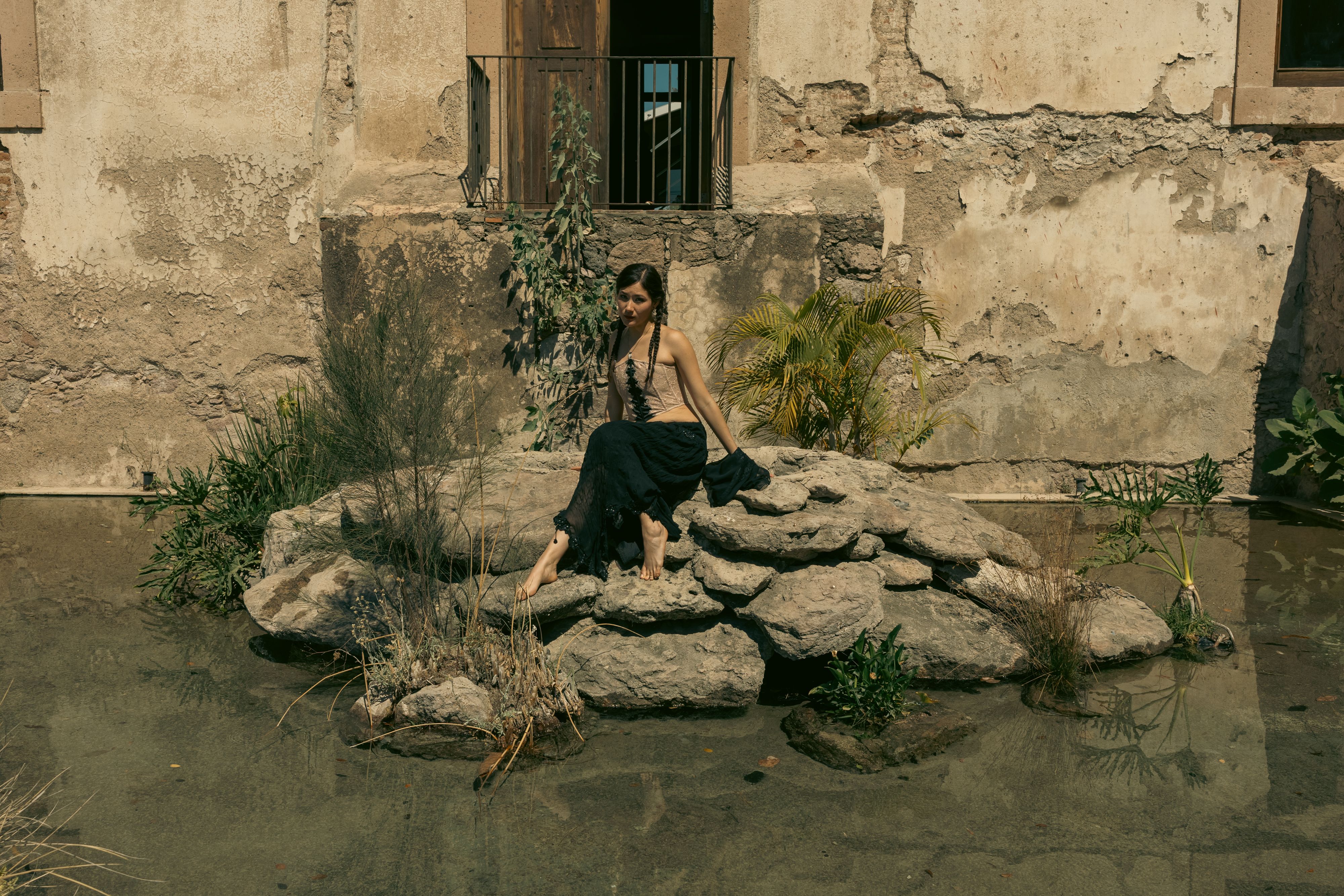 Woman Relaxing on Rocks in Rustic Setting · Free Stock Photo