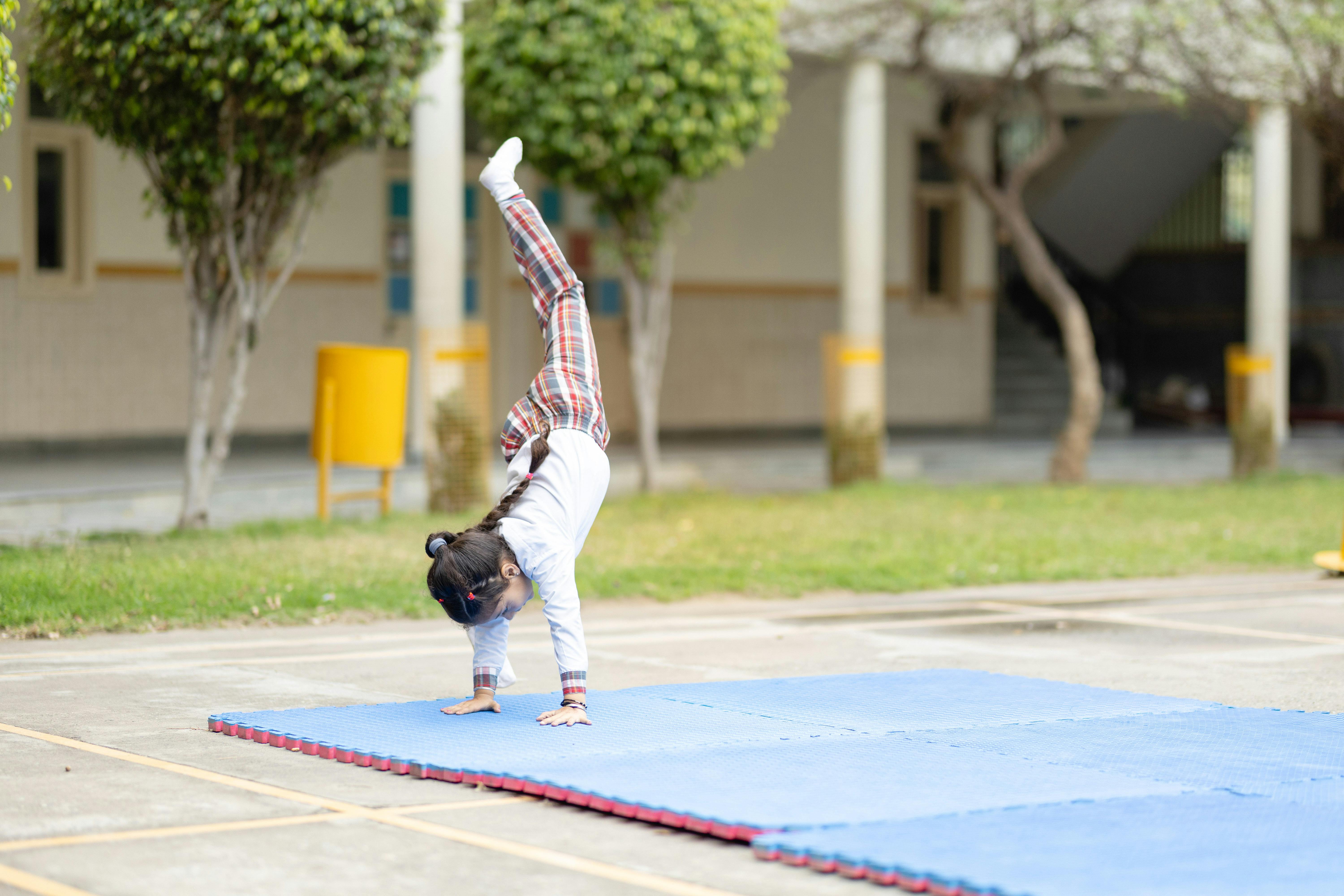 Young Girl Practicing Gymnastics Outdoors · Free Stock Photo