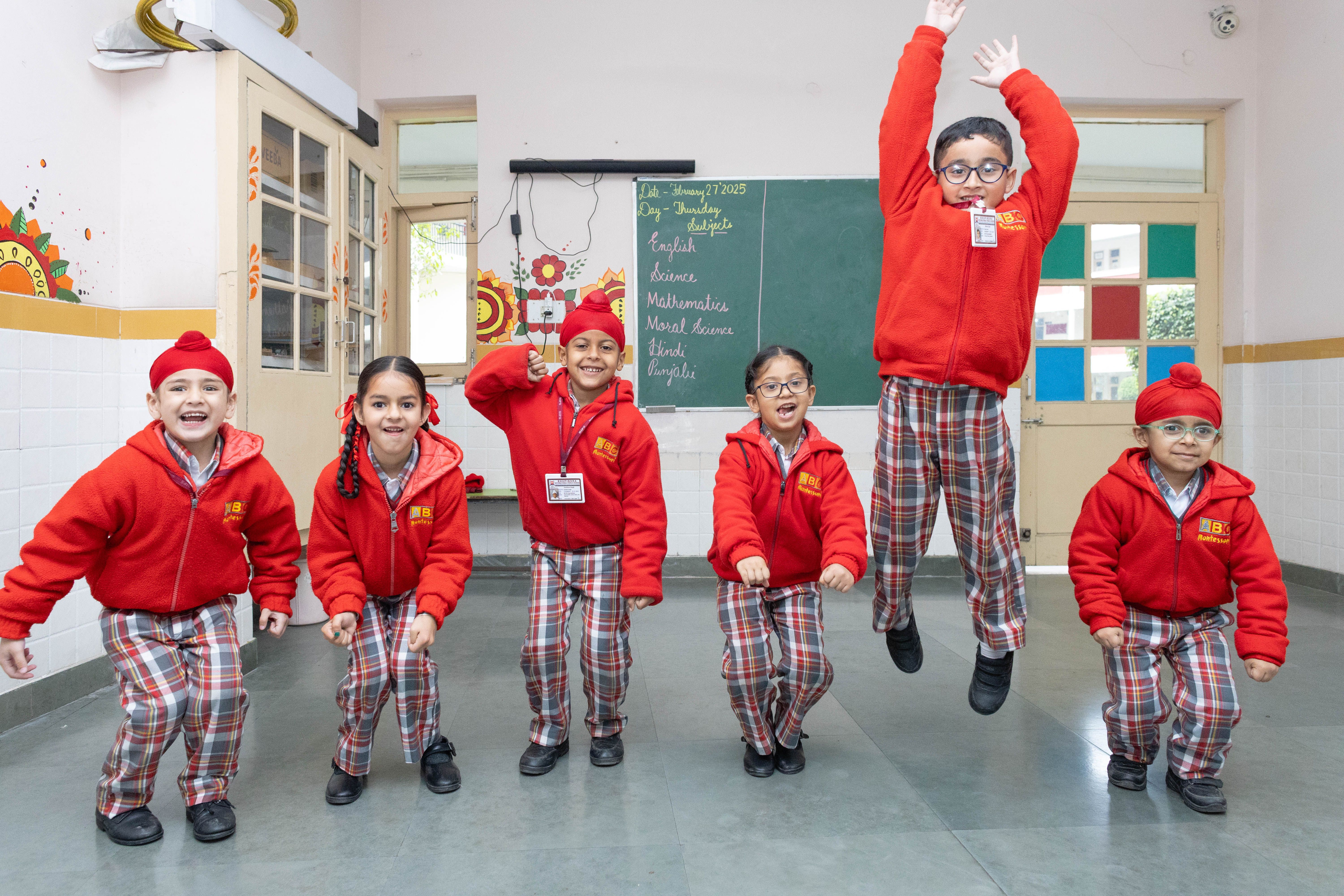 Joyful Children Jumping in School Classroom · Free Stock Photo