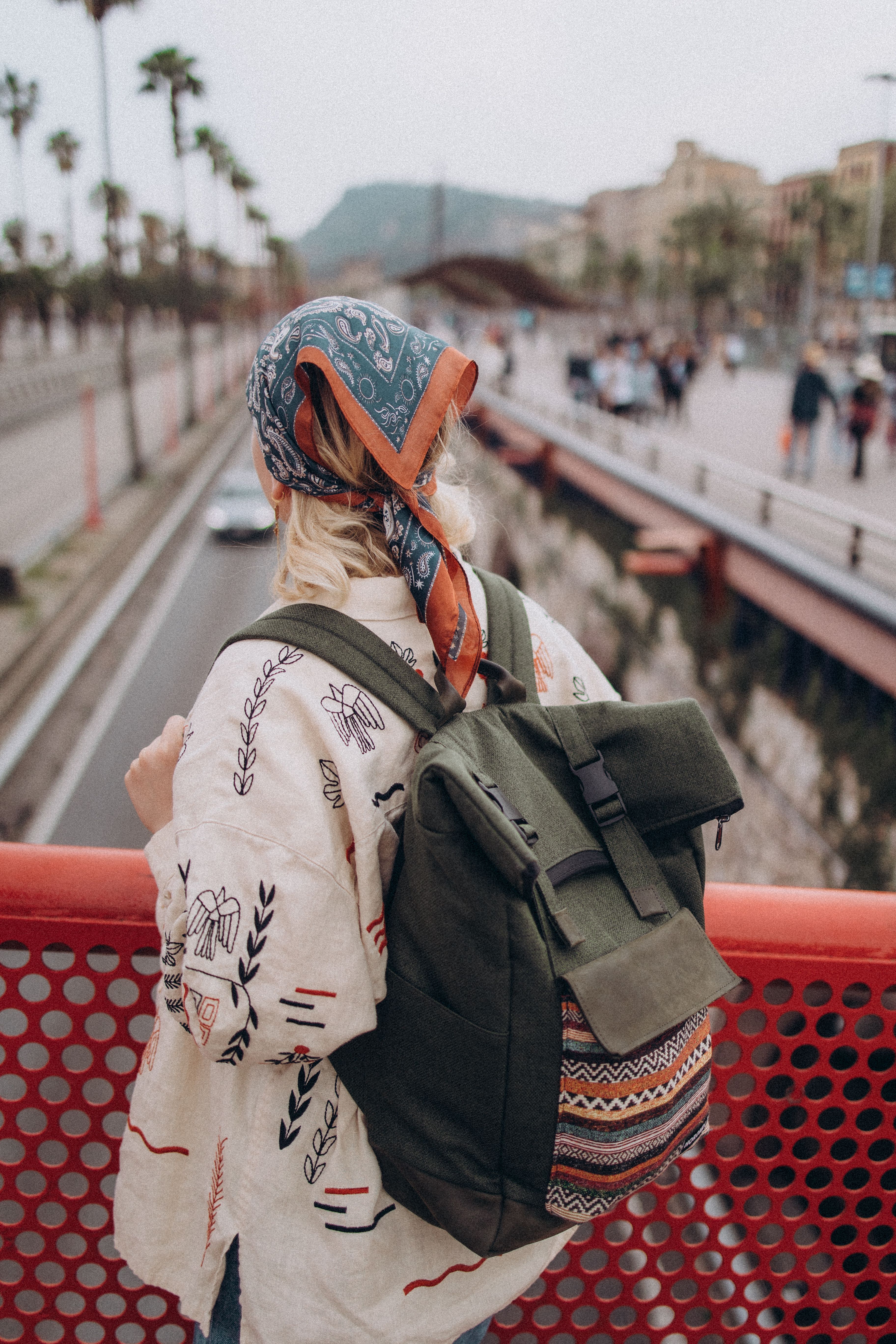 Traveler on Barcelona Bridge Overlooking City Streets · Free Stock Photo