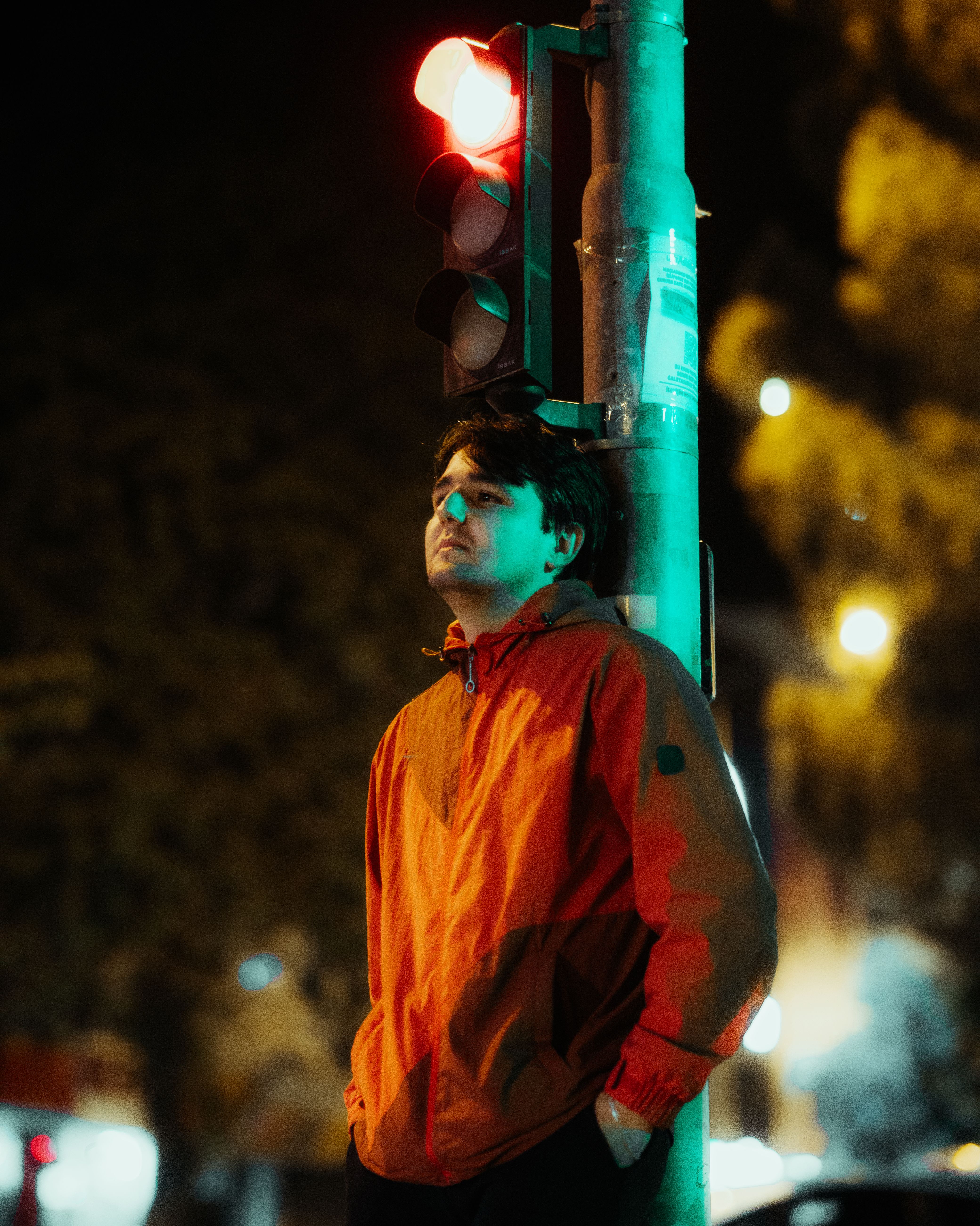 Man Standing at Traffic Light at Night · Free Stock Photo