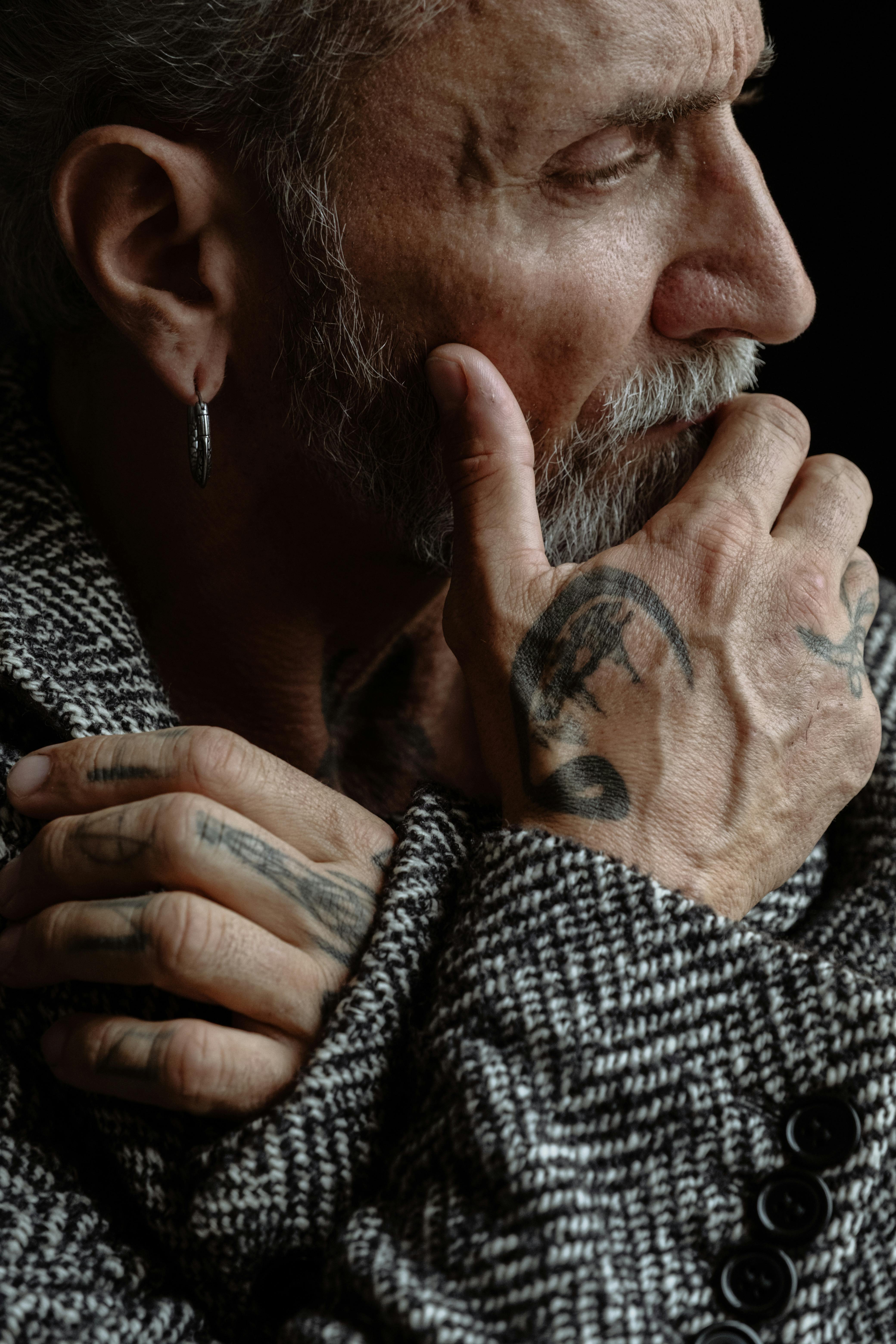 Thoughtful Senior Man with Tattoos in Tweed · Free Stock Photo